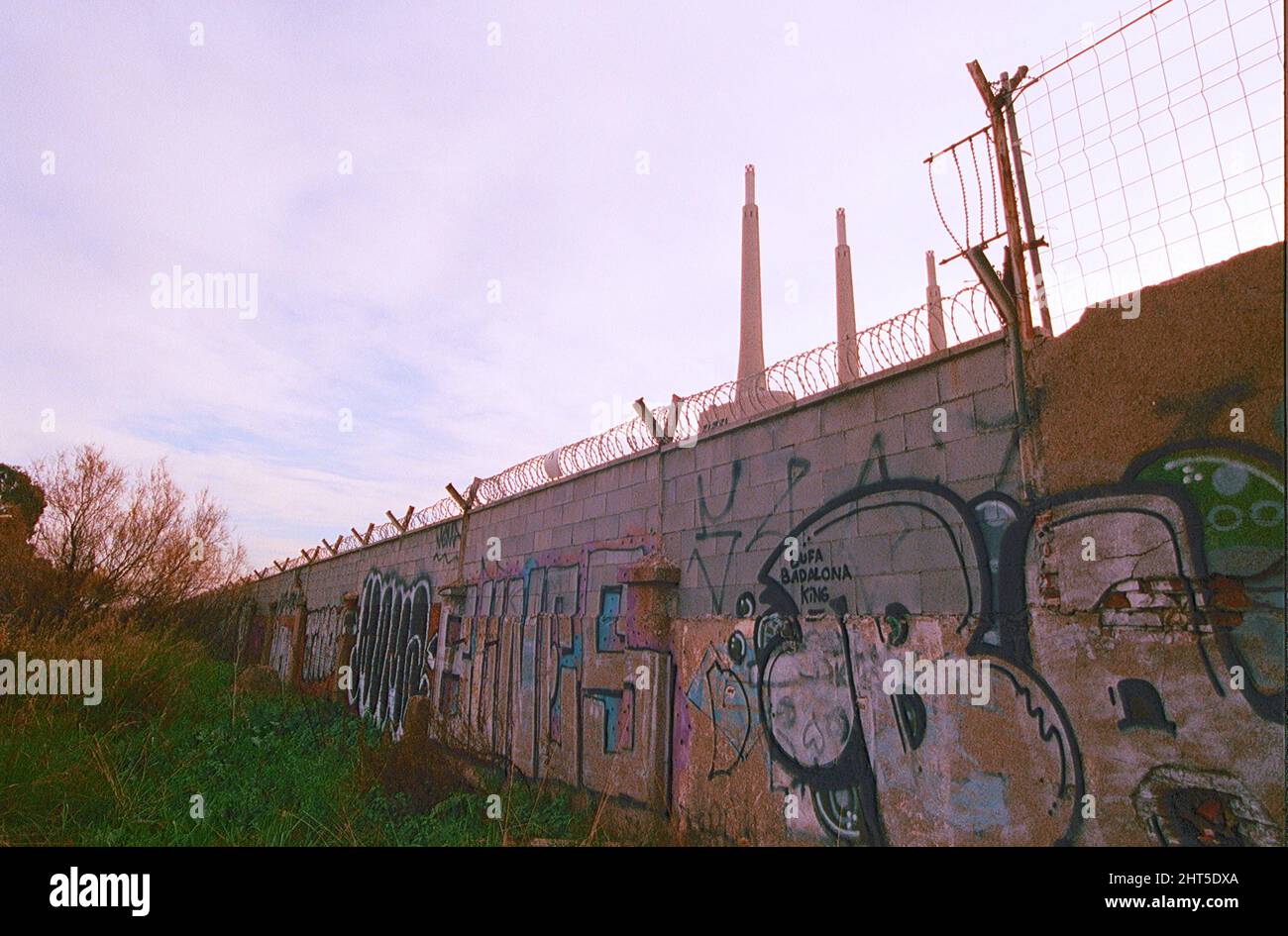 View of the graffiti painted barbed wire wall Stock Photo - Alamy