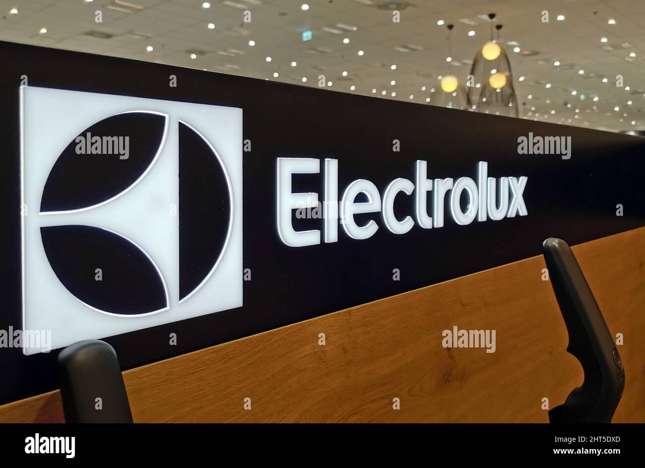 Closeup of an illuminated sign with the Electrolux logo in electronics and home appliance store ...
