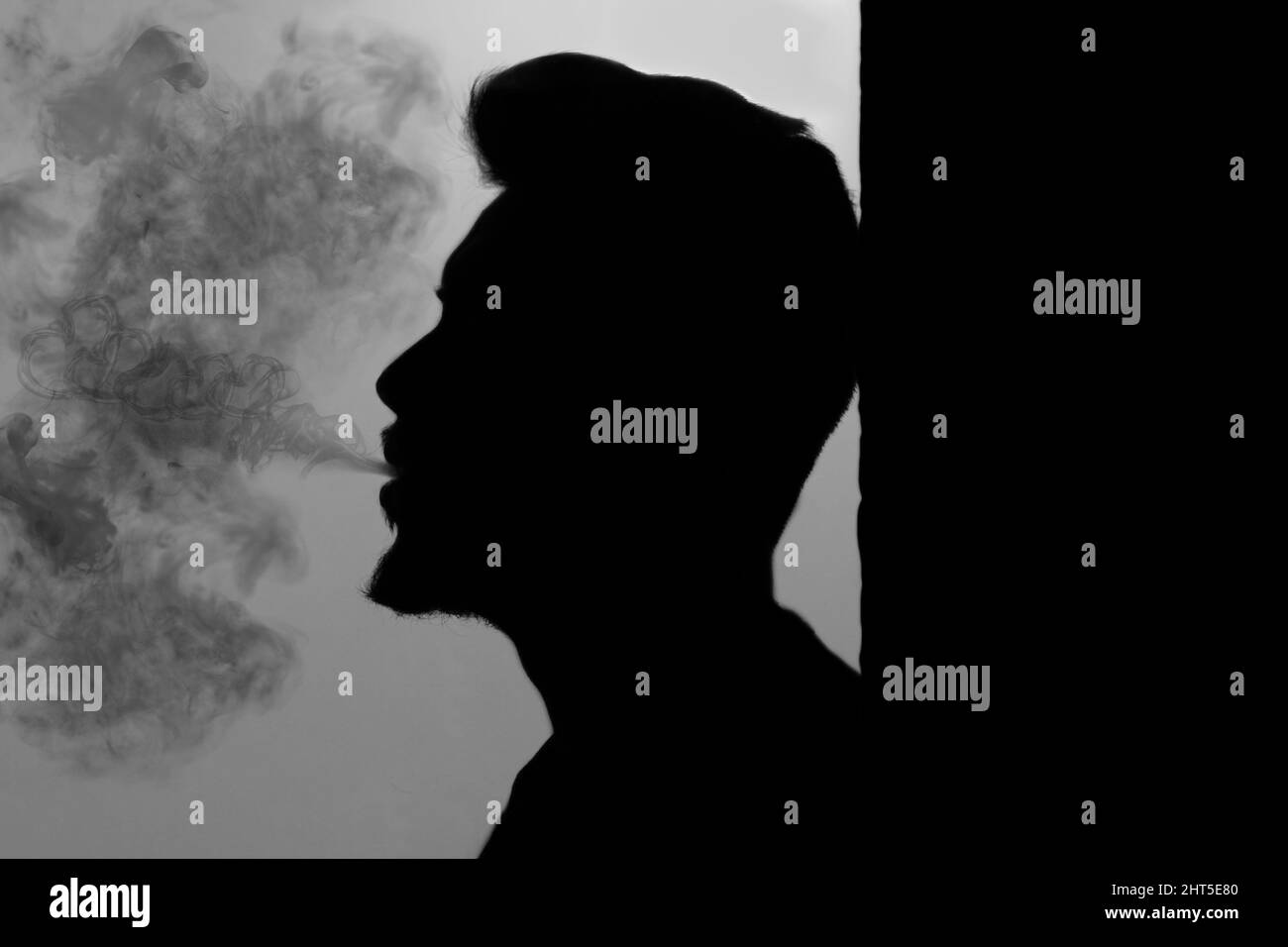 Silhouette of a male profile exhaling smoke Stock Photo - Alamy