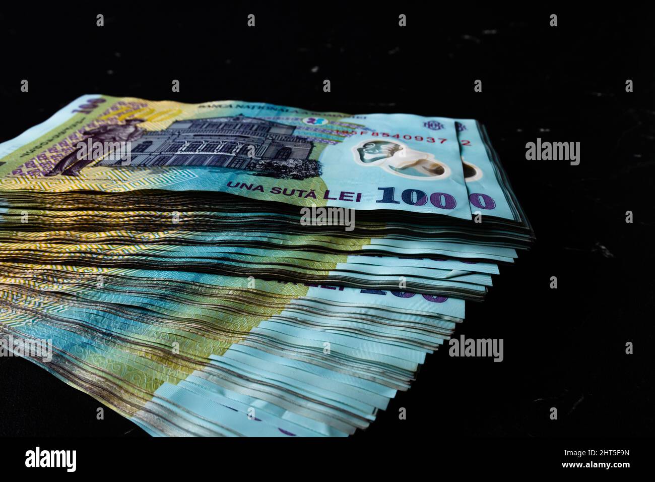 Closeup shot of a 100 leu banknotes stack isolated on black background ...
