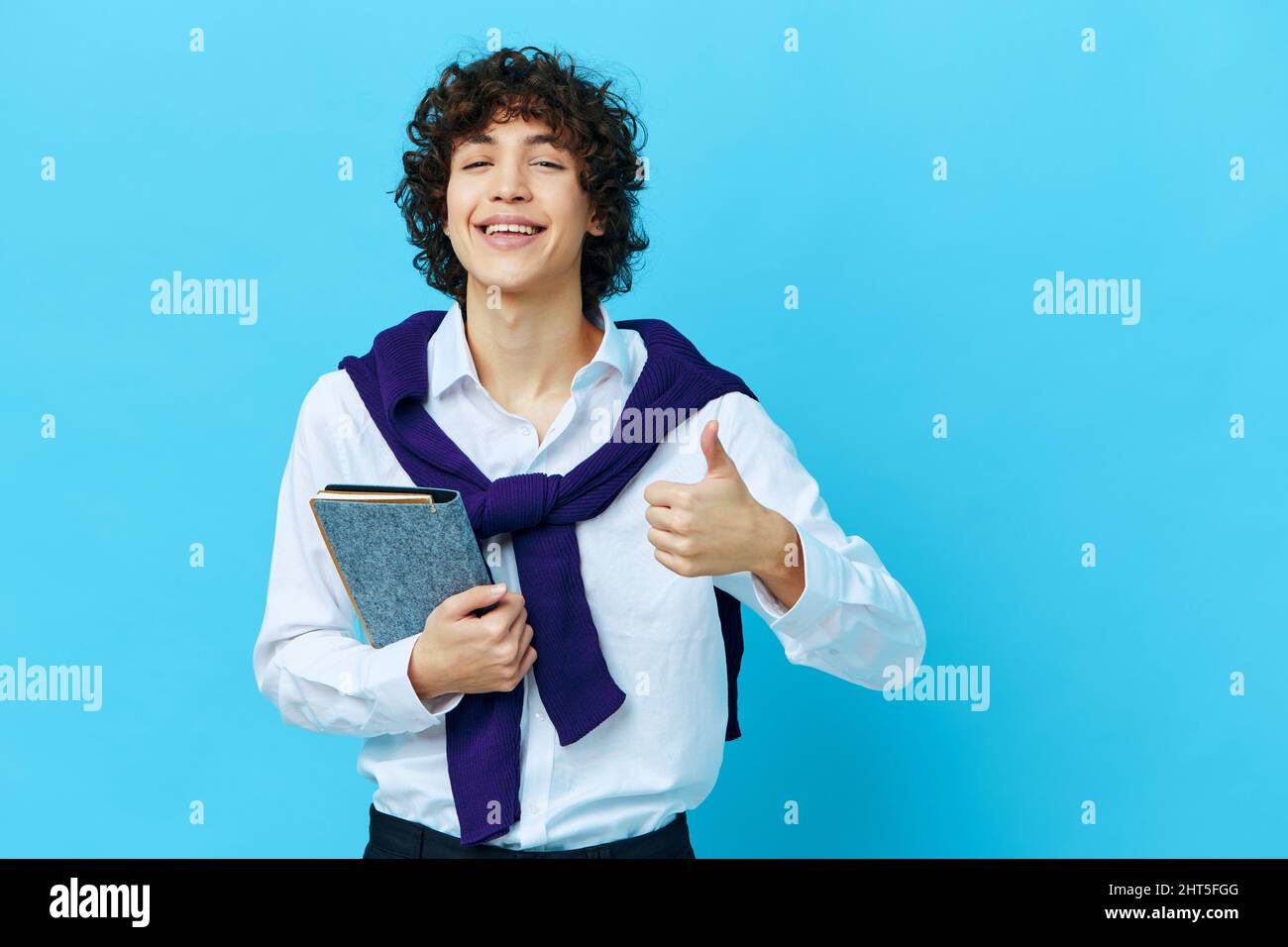student with a notepad in a sweater shirt on the shoulders cropped view ...