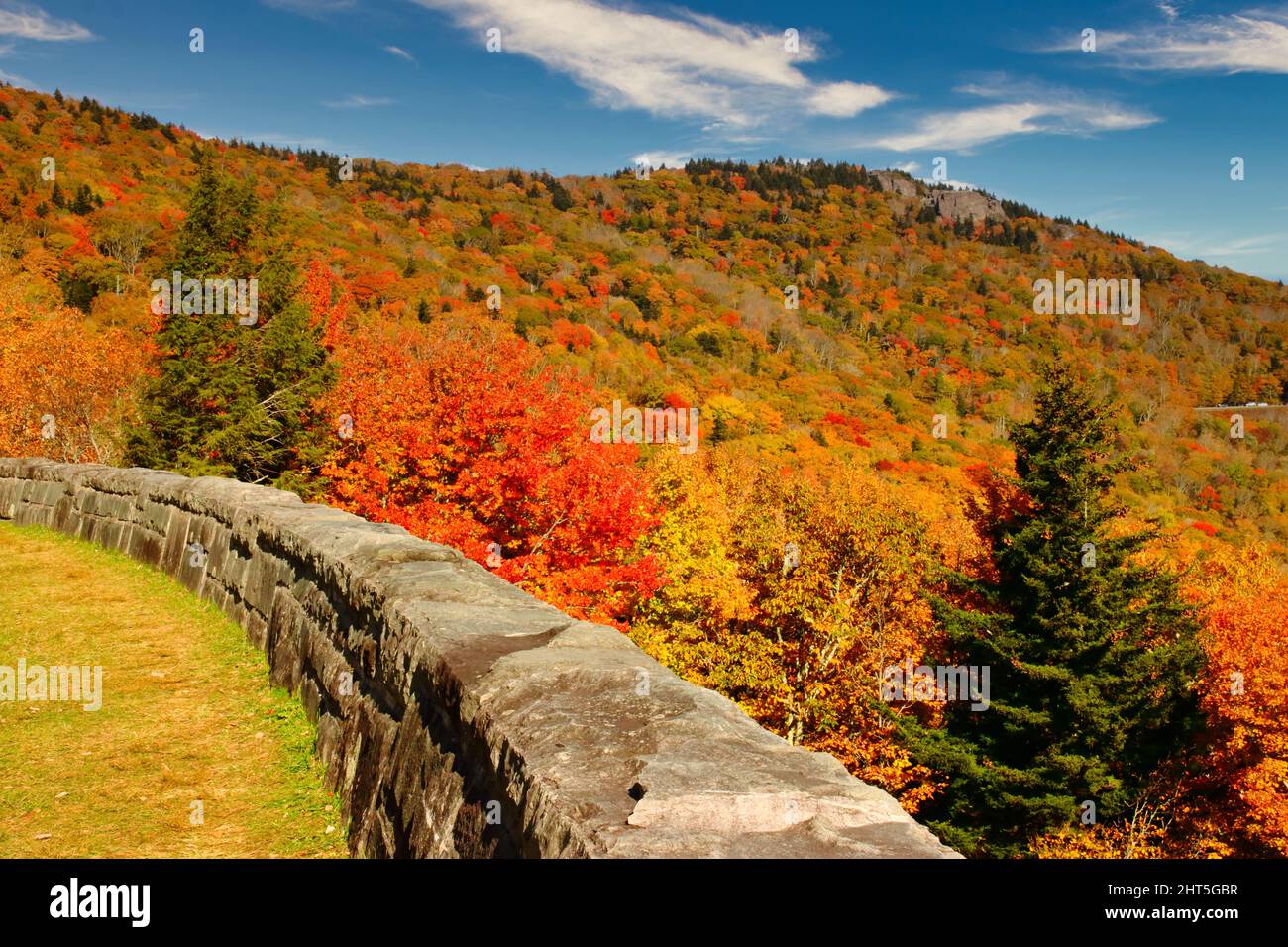 Beautiful view of concrete barricade along colorful autumn trees in ...