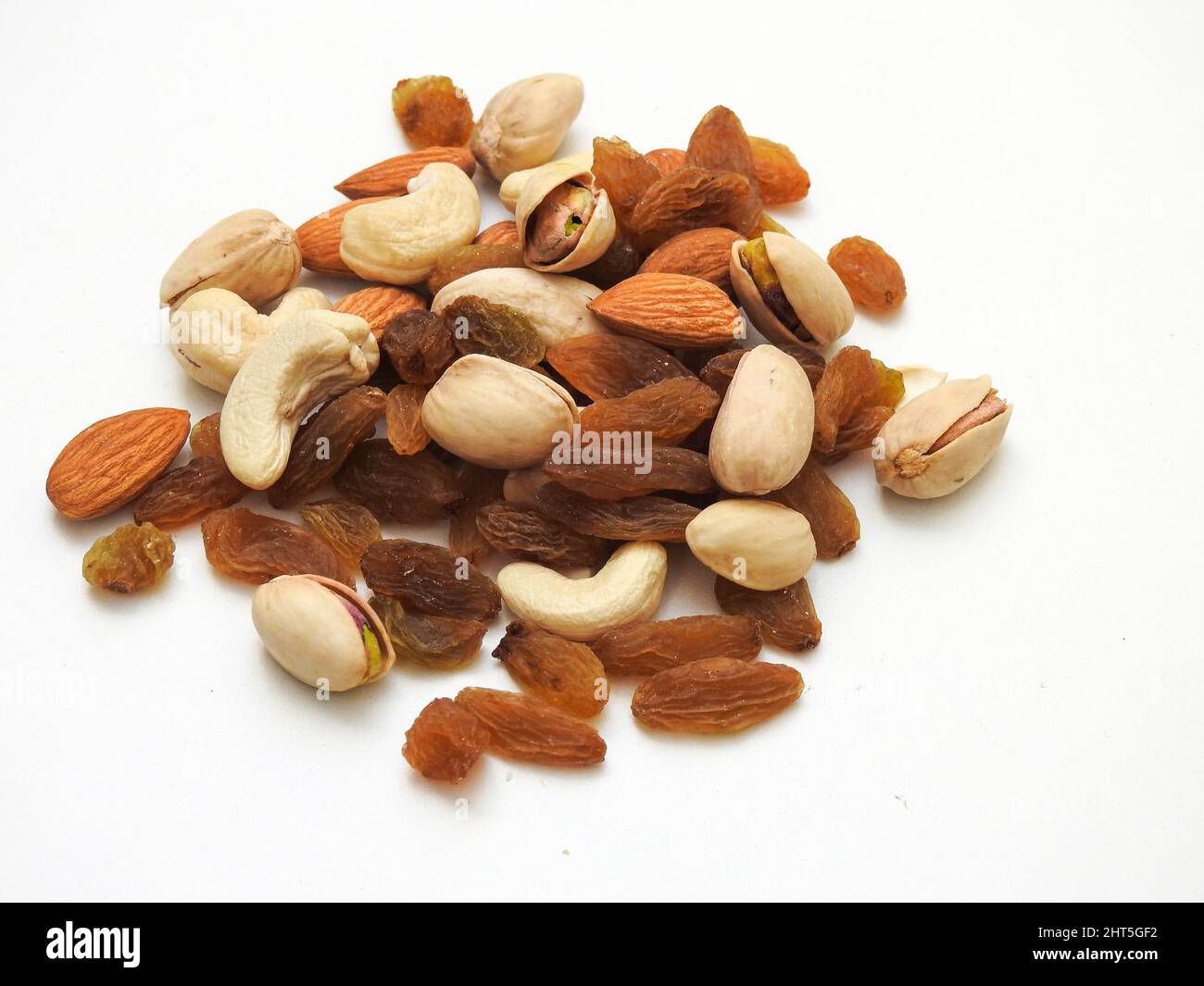 Closeup of a pile of mixed dry fruits isolated on white background ...