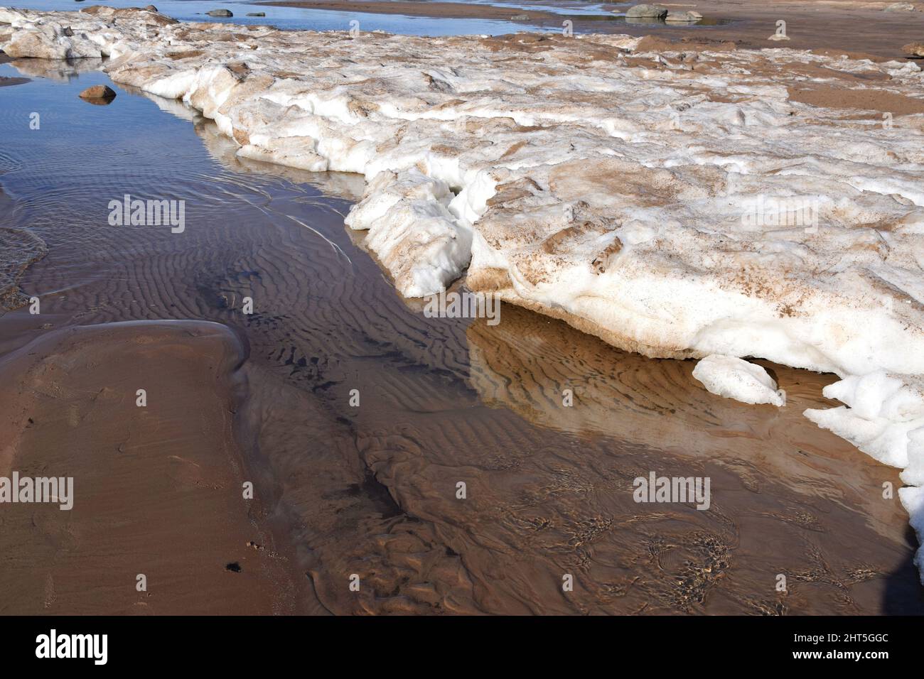 Beautiful landscape of a sandy beach with ice drifts Stock Photo - Alamy