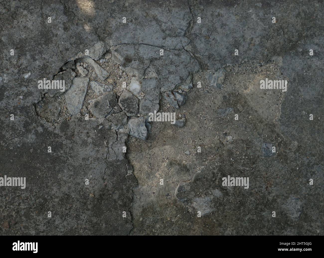cracked cement covered with gray cement surface as background for ...