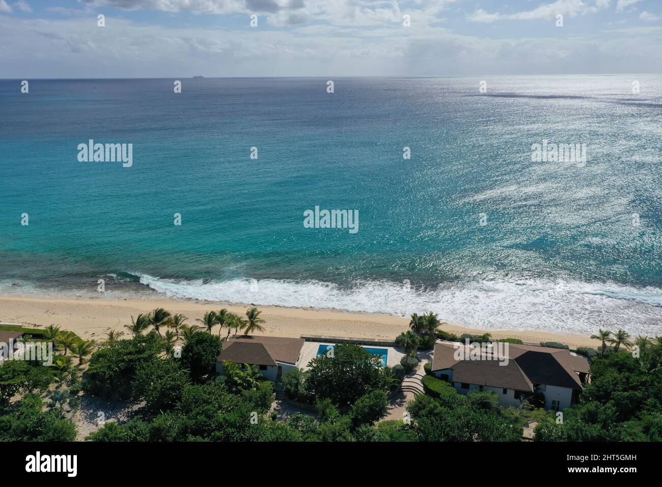 Aerial view of the sea waves touching the sandy beach of St. Martin ...