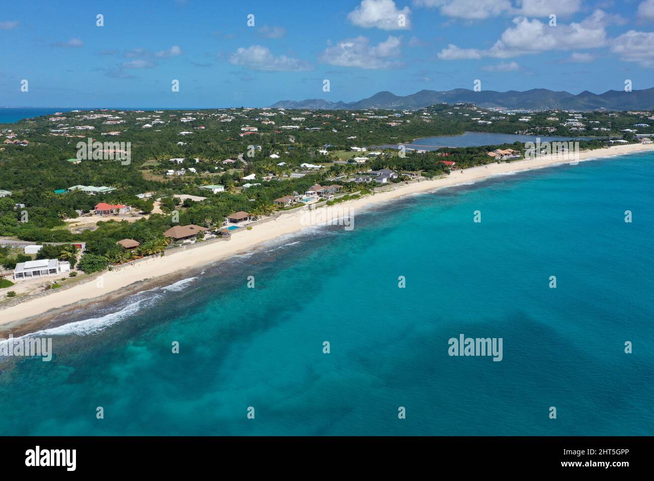 Aerial view of the sea waves touching the sandy beach of St. Martin ...