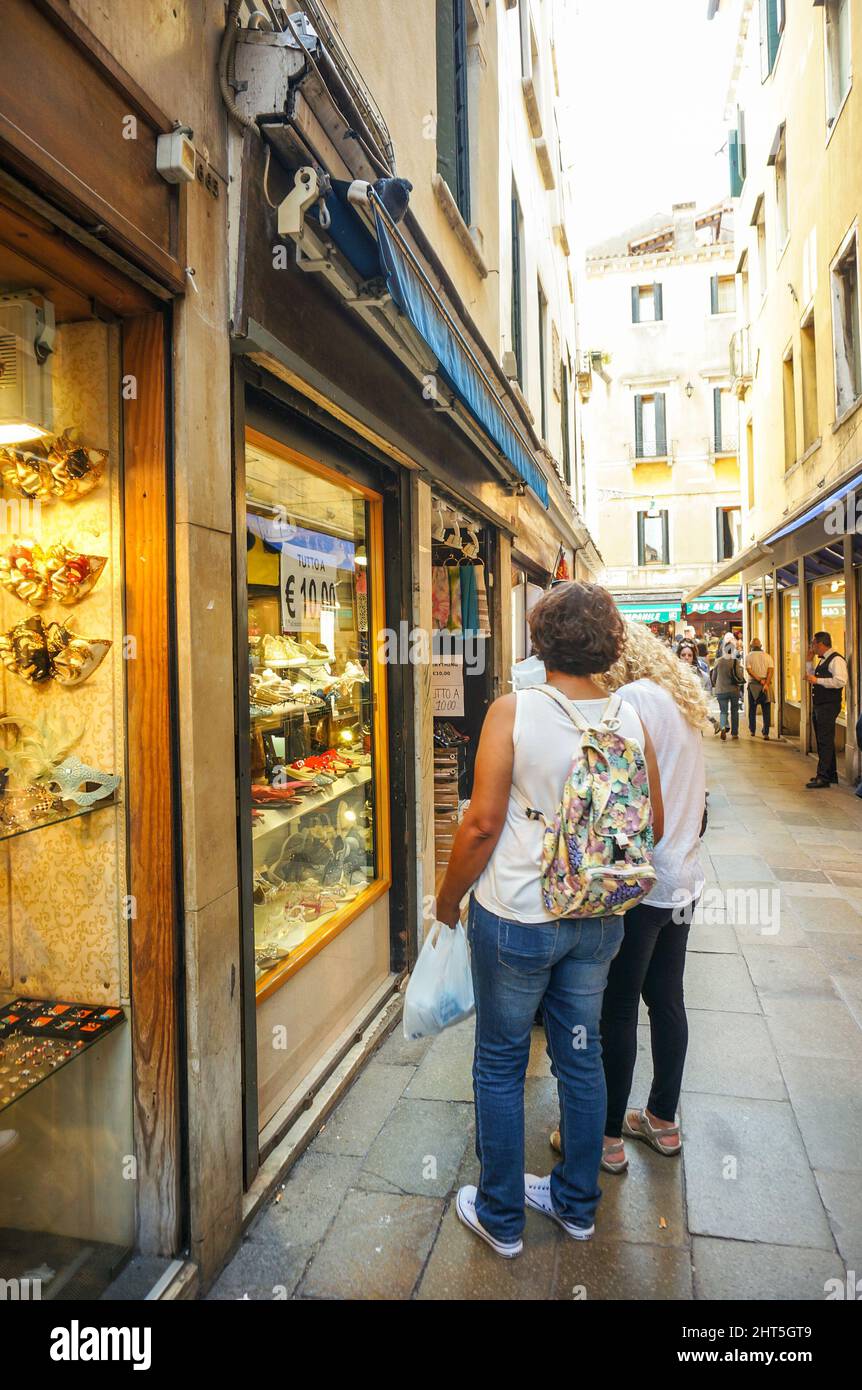 Shot of People standing in front of a small shop with souvenirs in the ...