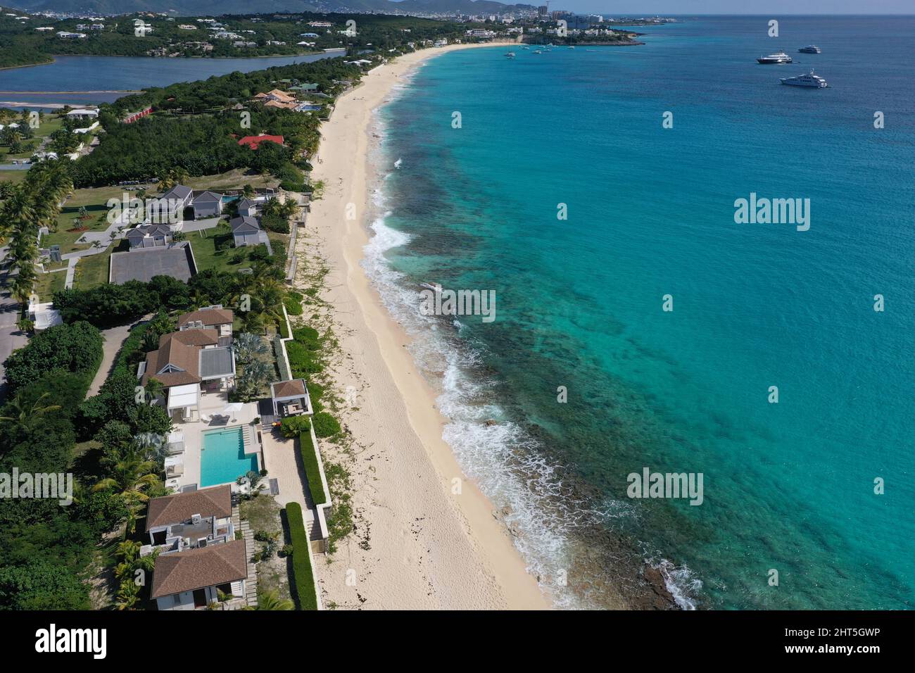 Aerial view of the sea waves touching the sandy beach of St. Martin ...