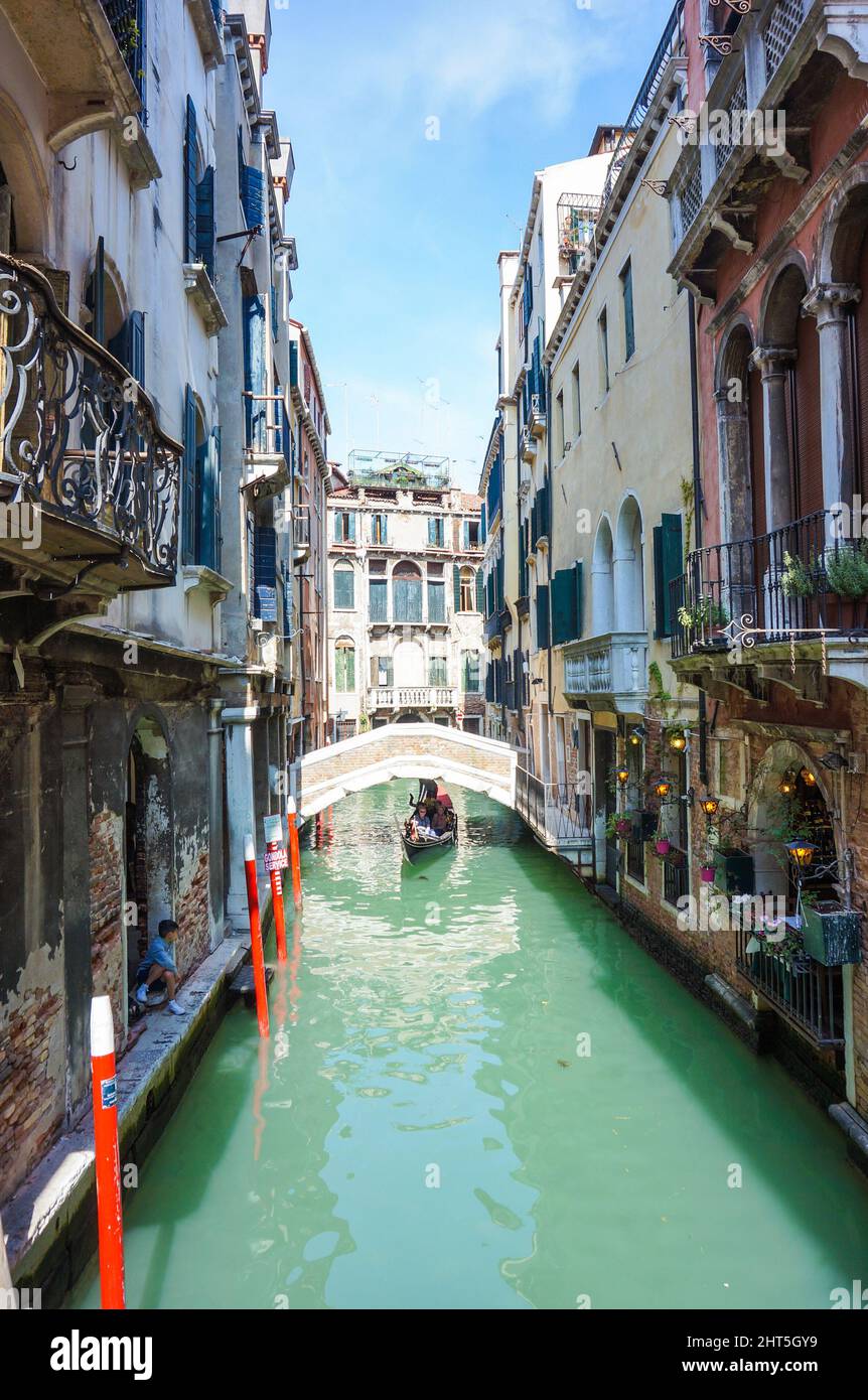 Small canal with gondola between buildings Stock Photo - Alamy