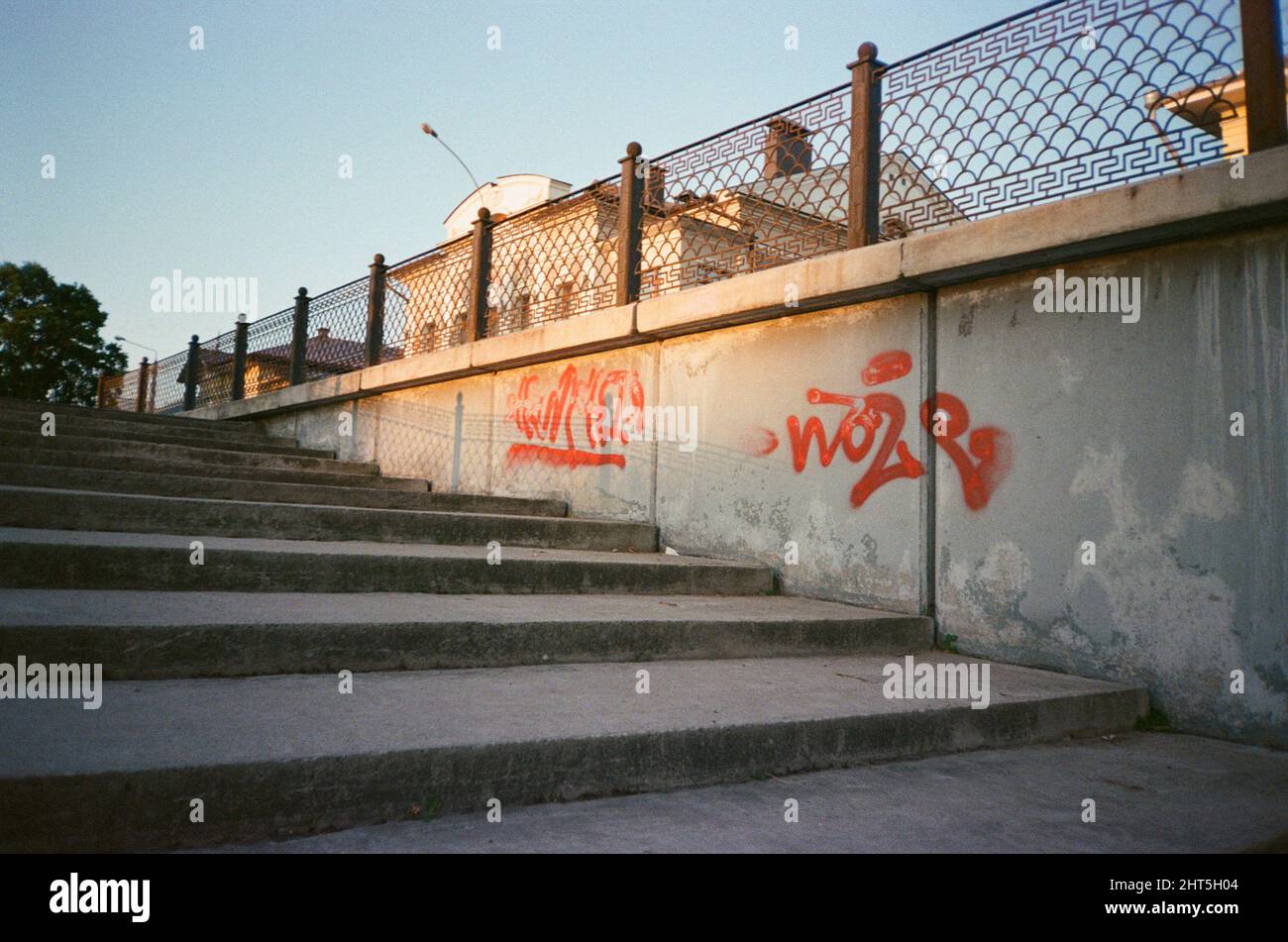 View of staircase with wall of red graffiti words Stock Photo - Alamy