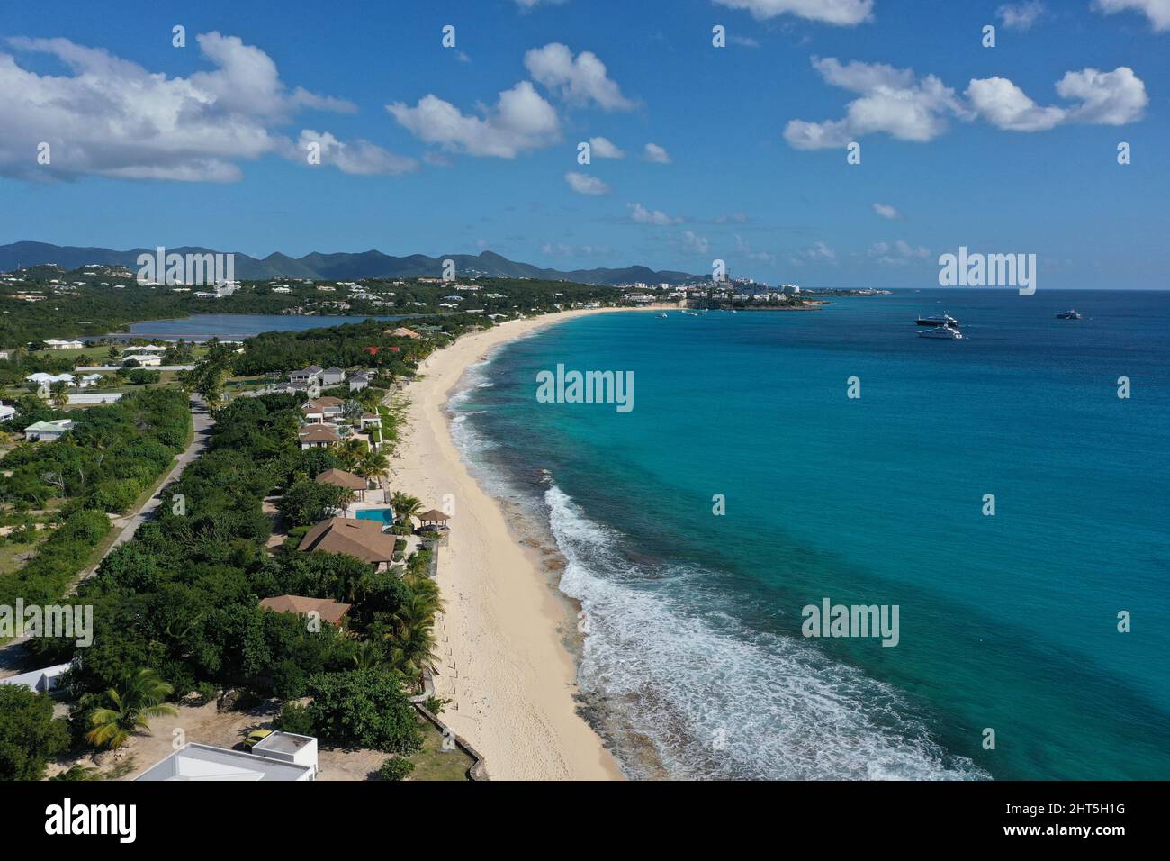Aerial view of the sea waves touching the sandy beach of St. Martin ...