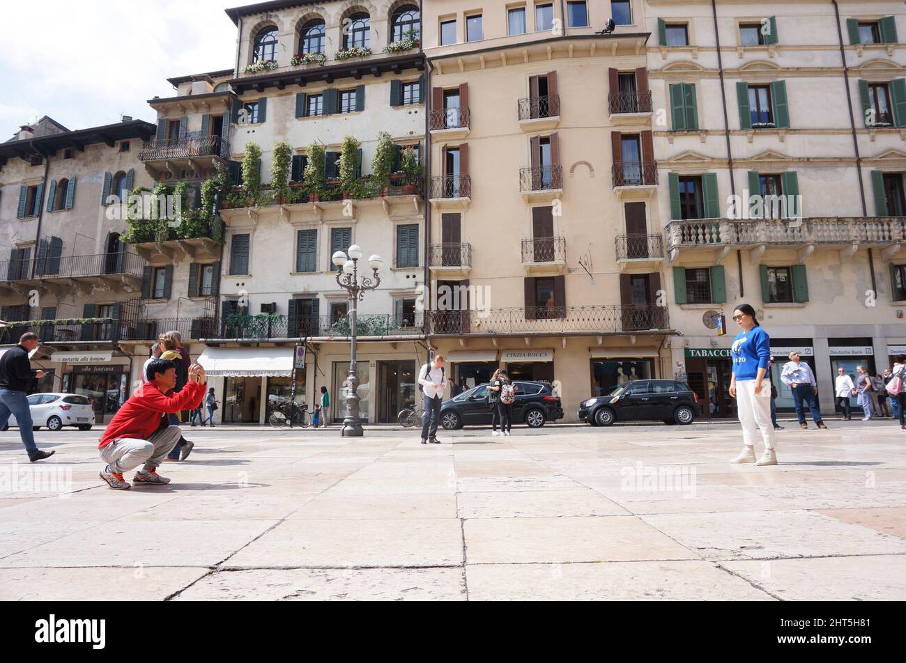 Man taking a photo of a woman on a square in the city center Stock ...