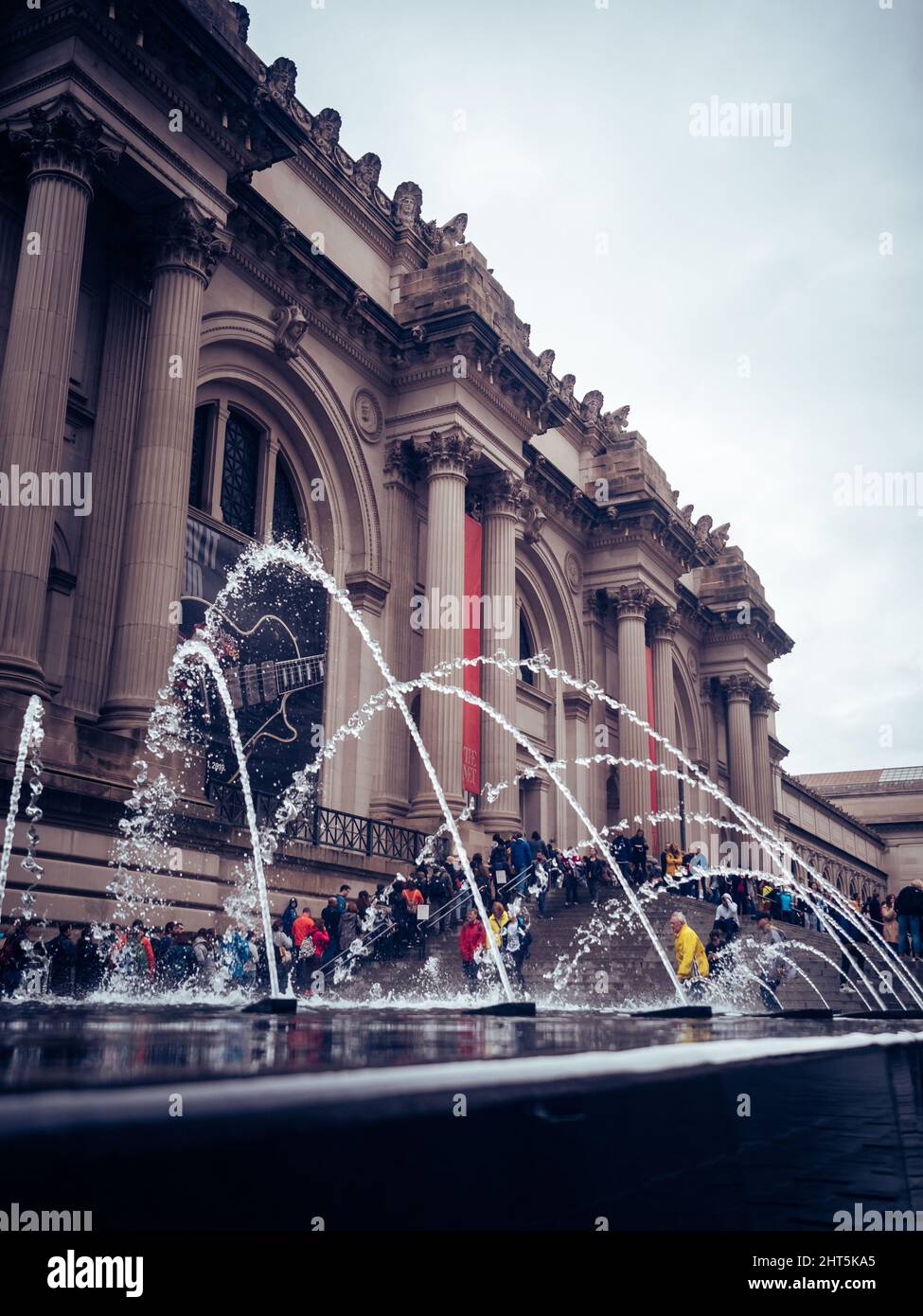 Vertical shot of a fountain in front of an old building in New York ...