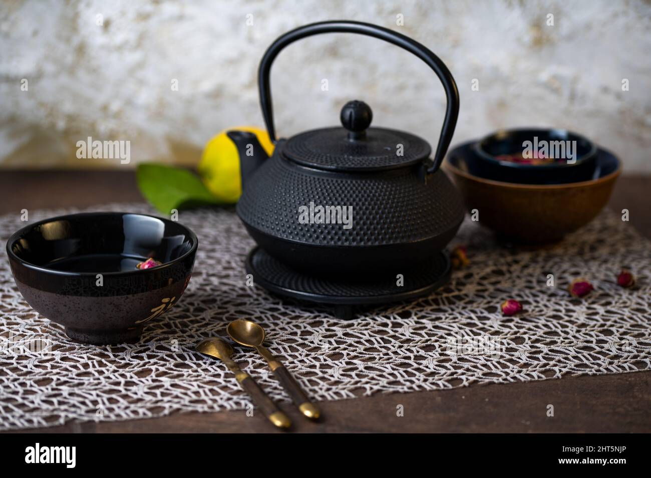 Tea table with a black ceramic kettle and cups on it Stock Photo - Alamy