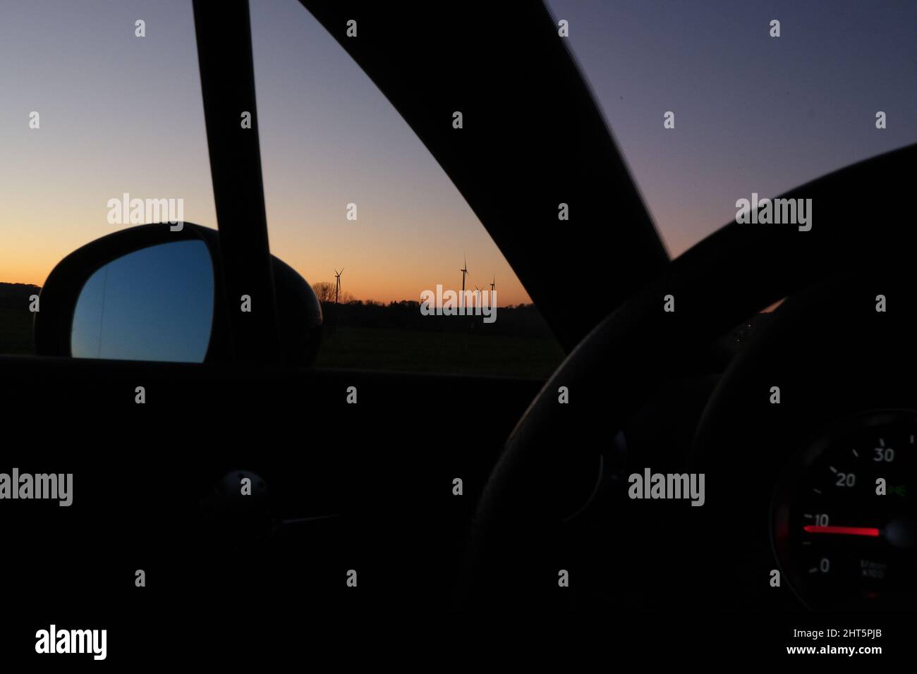 Closeup of the blurred steering wheel with sunset background Stock ...