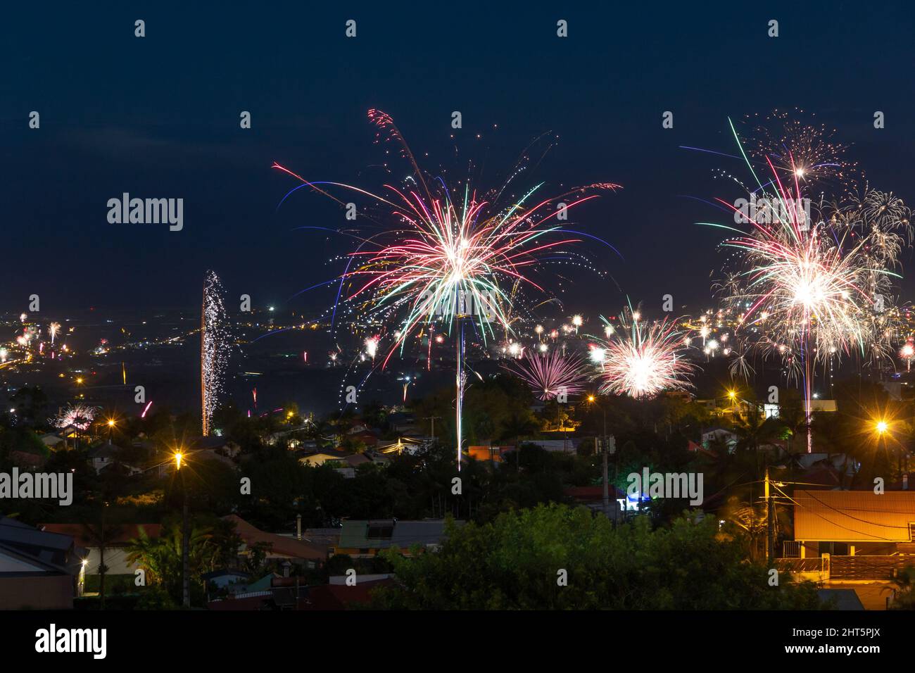 Beautiful cityscape view with colorful fireworks and street lamps at ...