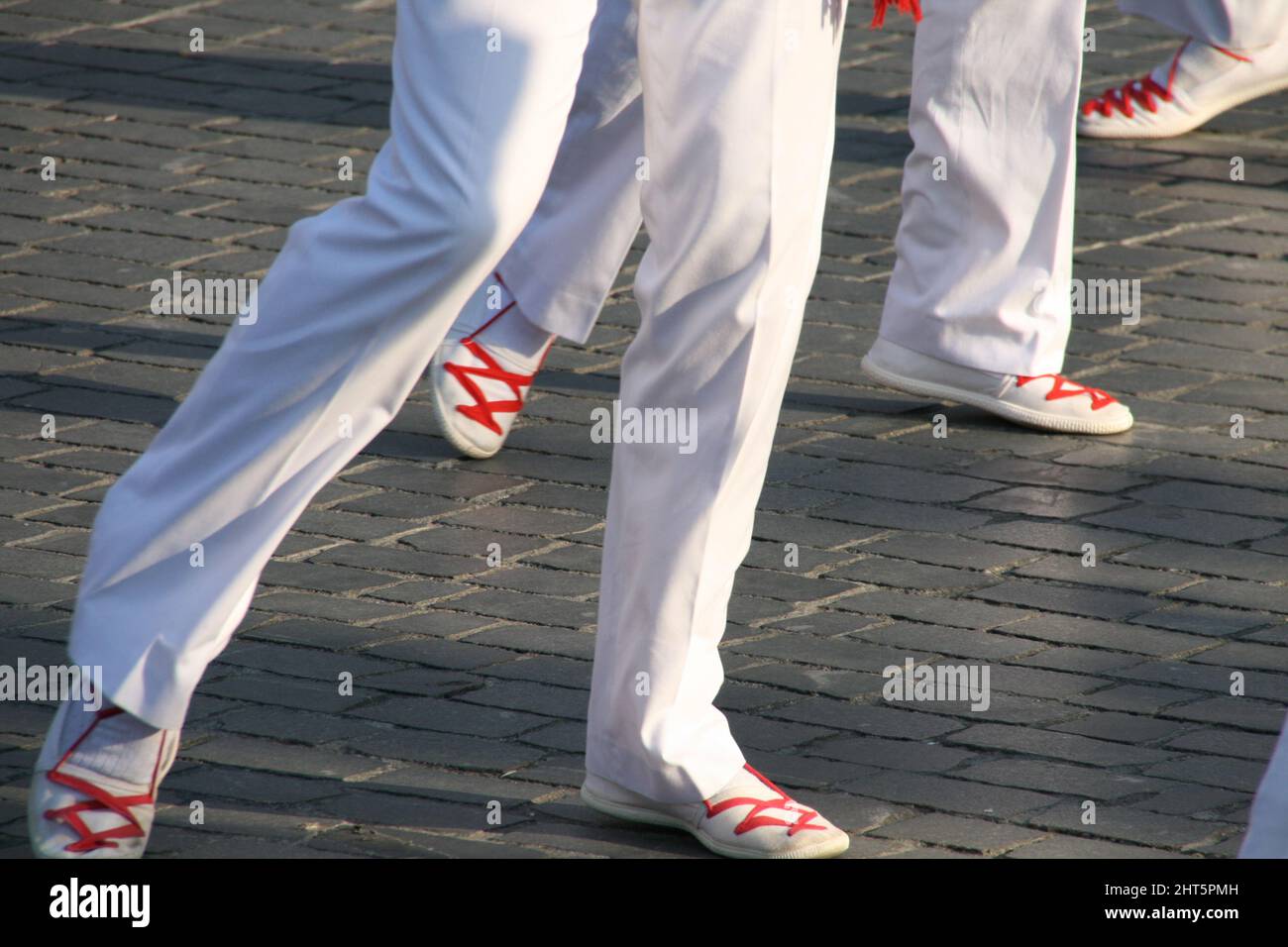 Closeup of male legs wearing a white costume, dancing Basque folk ...
