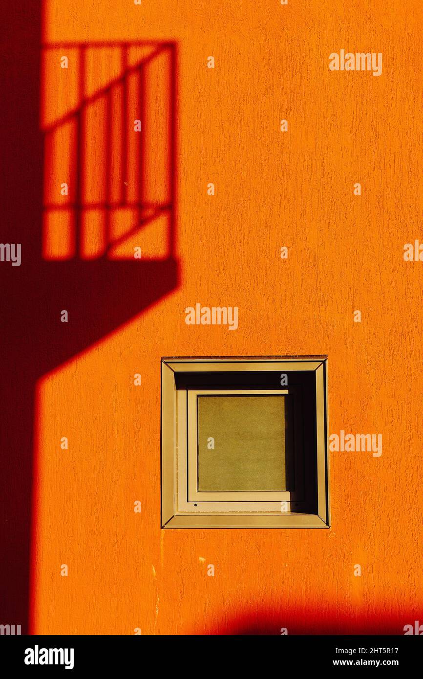 Minimalistic shot of a window on an orange building Stock Photo - Alamy