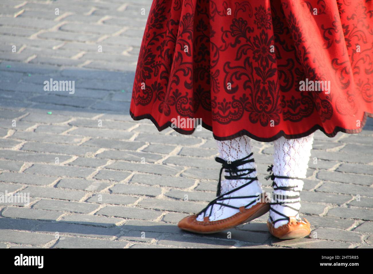 Closeup of female feet wearing a red national skirt, dancing Basque ...