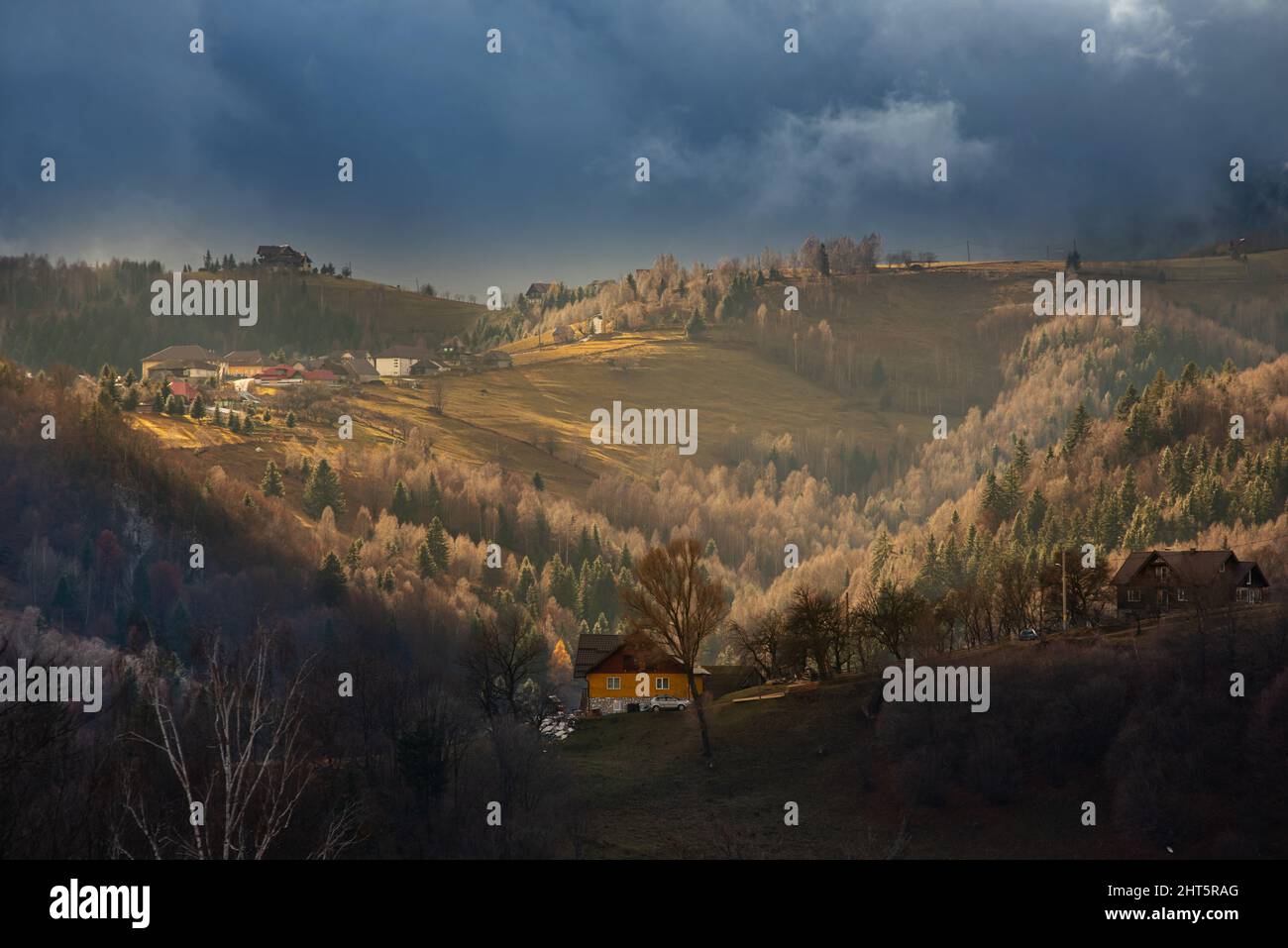 Landscape with a forest and a village in Romania Stock Photo - Alamy