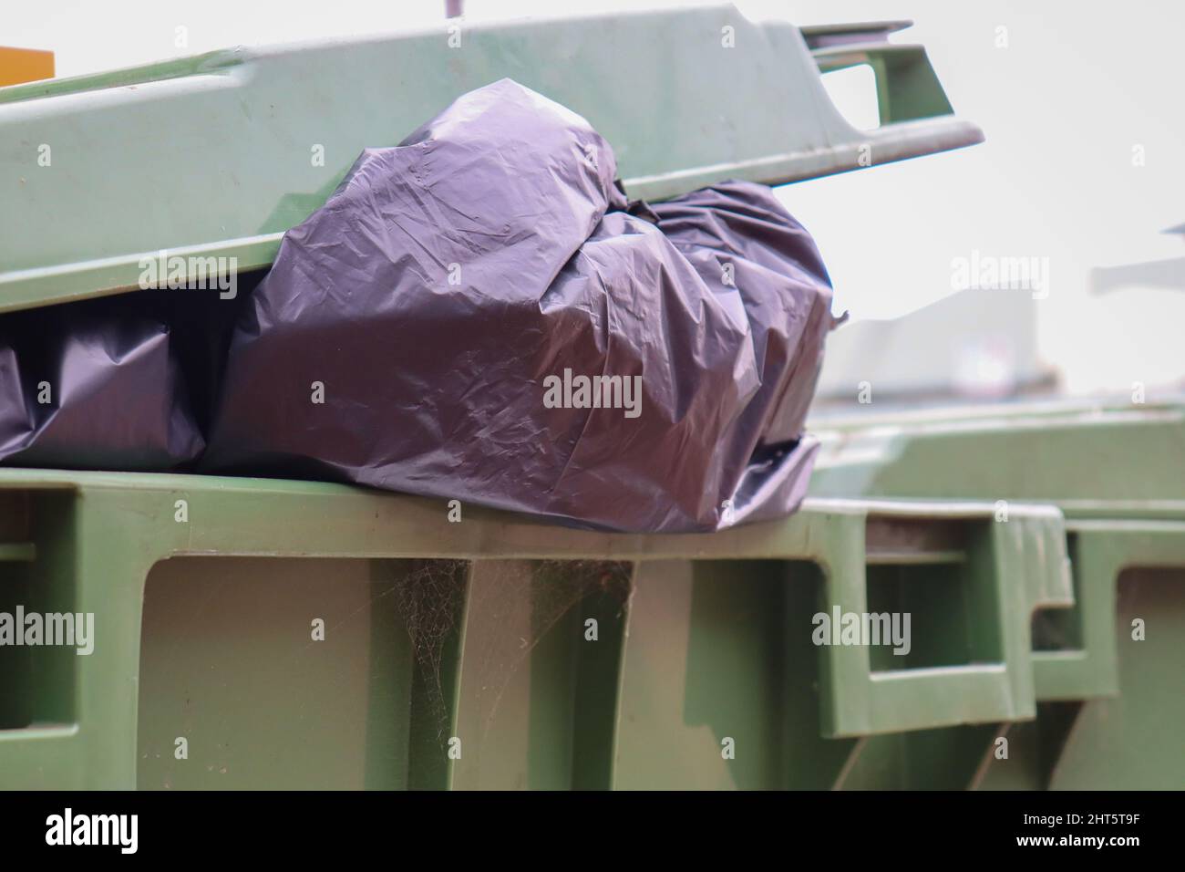 Plastic bag of trash in a container Stock Photo - Alamy