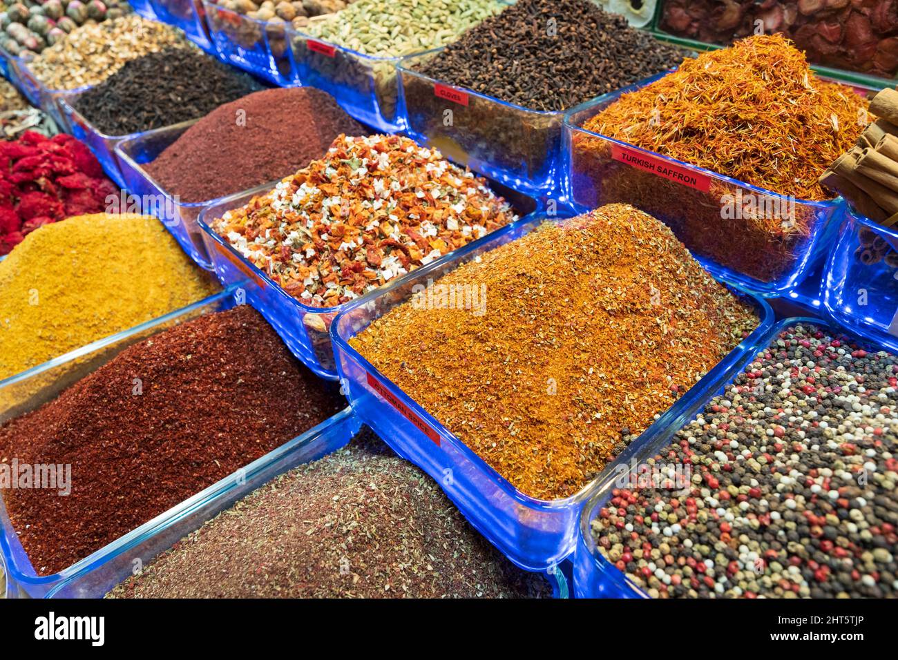 Lot of dry spices in blue plastic containers in the street market Stock ...