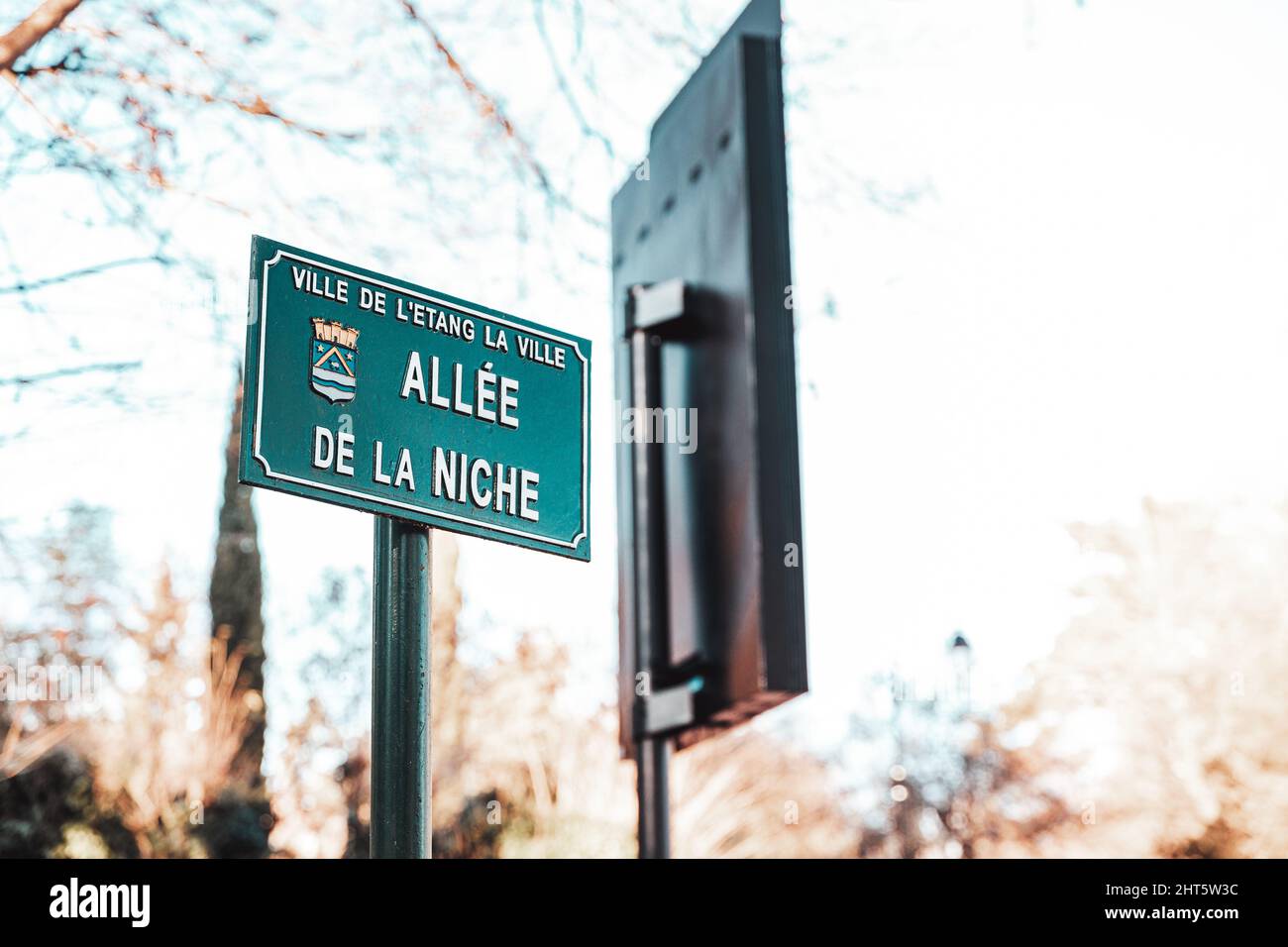 Low angle shot of a green street sign with text ALLEE DE LA NICHE in ...