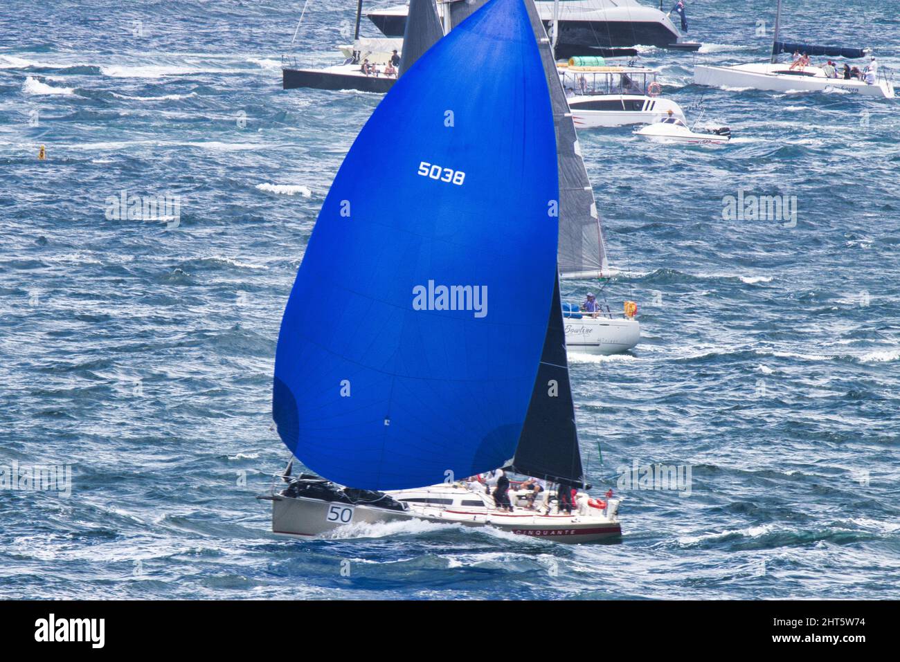 Small yacht with a blue spinnaker on Sydney Harbour during the 2021 ...
