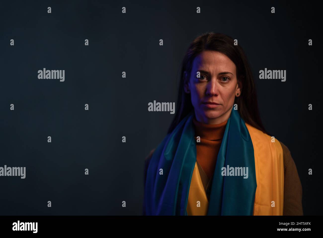 Sad woman covered with Ukraine flag. Concept of standing with Ukrainian ...