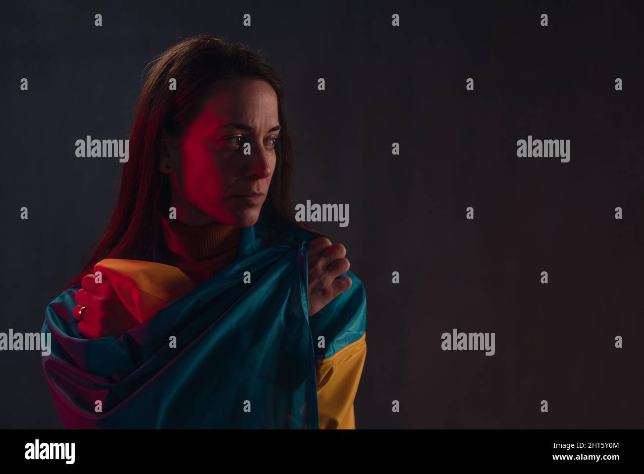 Sad woman covered with Ukraine flag. Concept of standing with Ukrainian ...