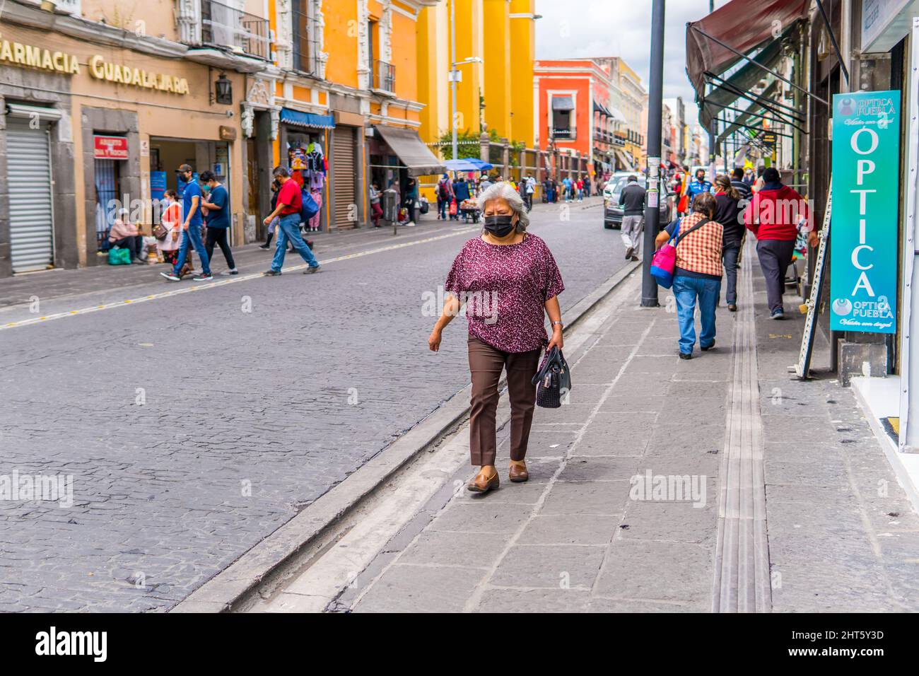 Beautiful shot of people walking in a street with traditional buildings ...
