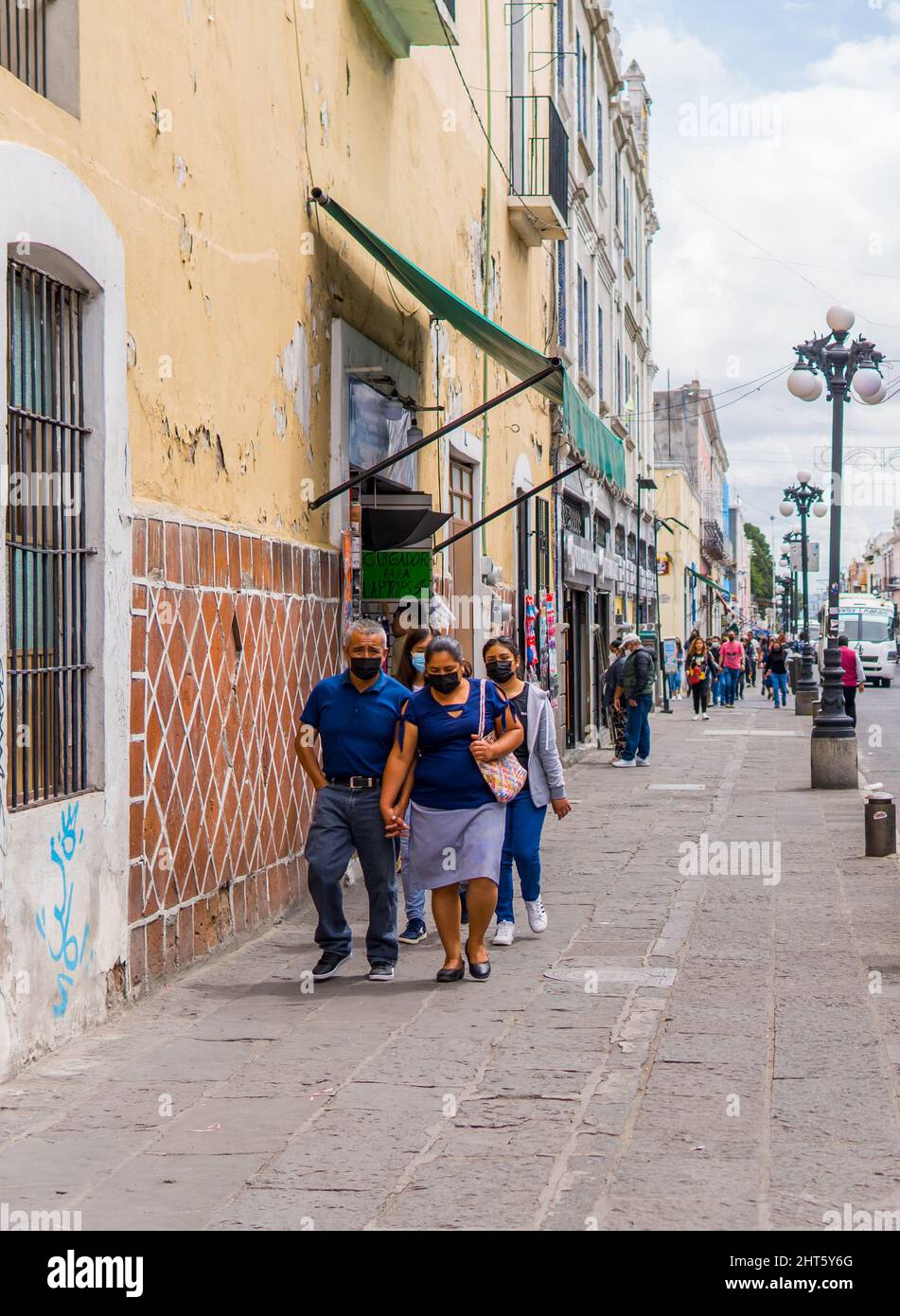 Beautiful shot of people walking in a street with traditional buildings ...