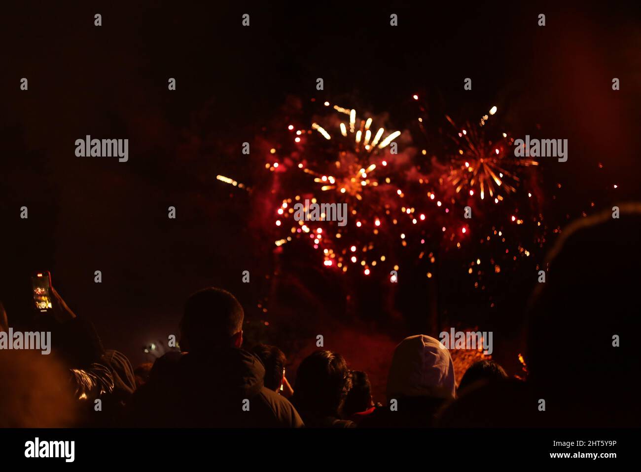 People watching beautiful fireworks in the street Stock Photo - Alamy