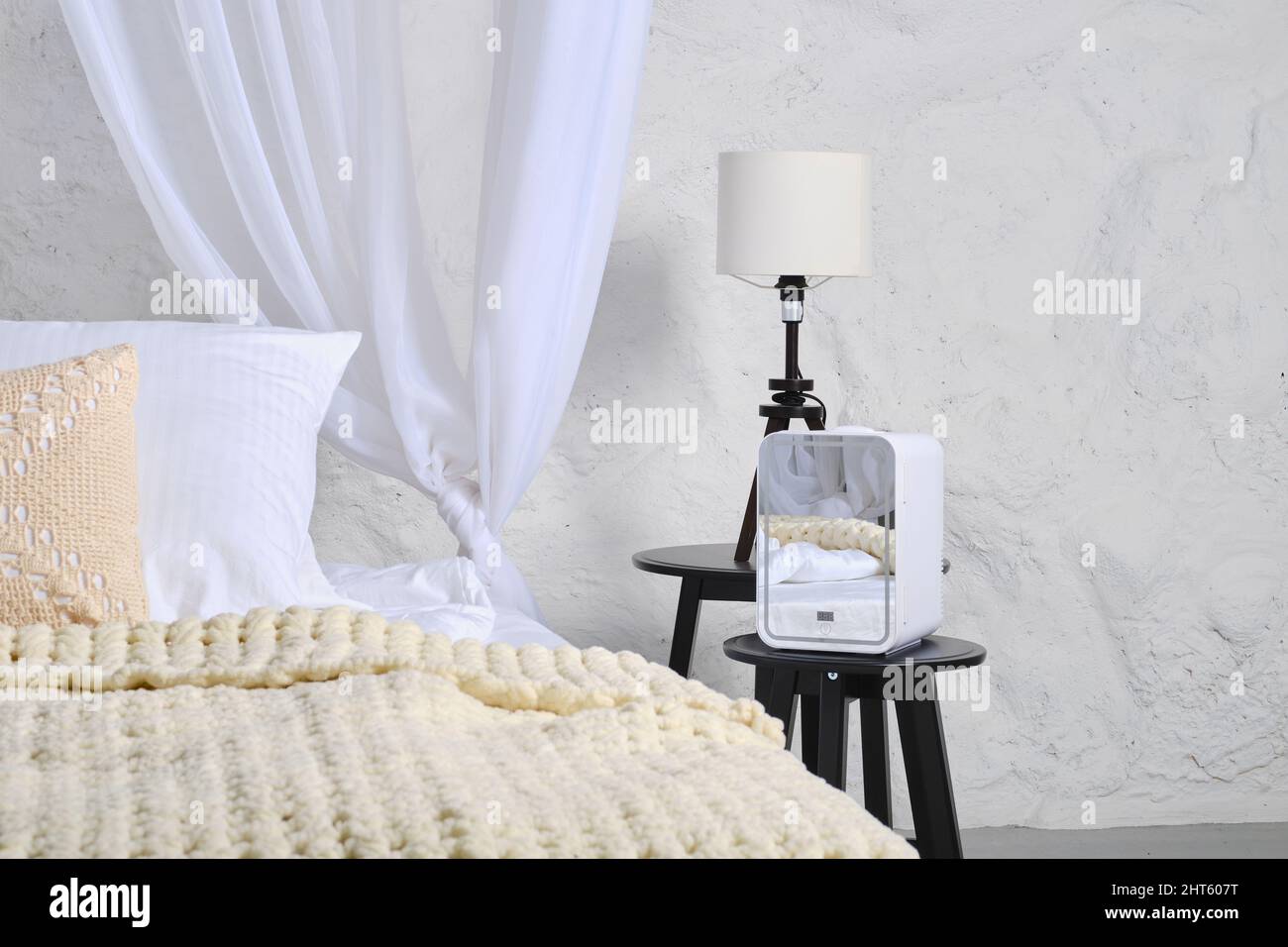 Compact and portable fridge with mirror on a chair near the bed in ...