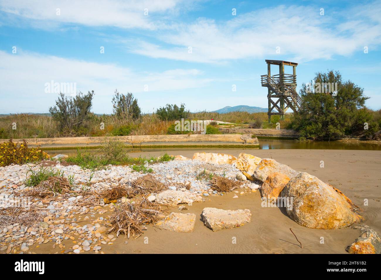Scenic view of a river flowing through rocky fields with greenery near ...