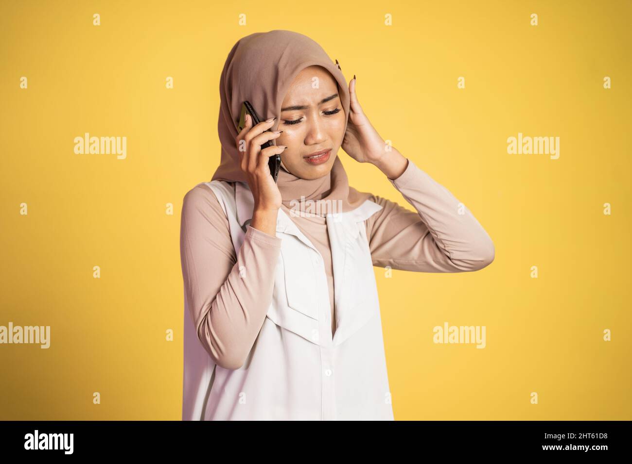 worried muslim woman in hijab making a call using a cell phone Stock ...