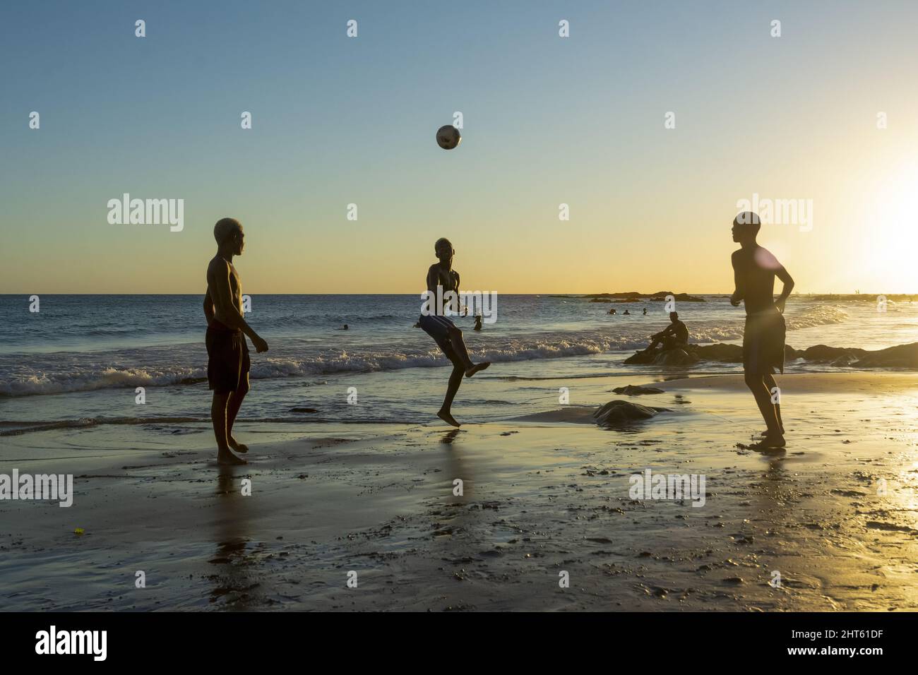 Silhouette of young people playing sand football on the beach of Ondina ...