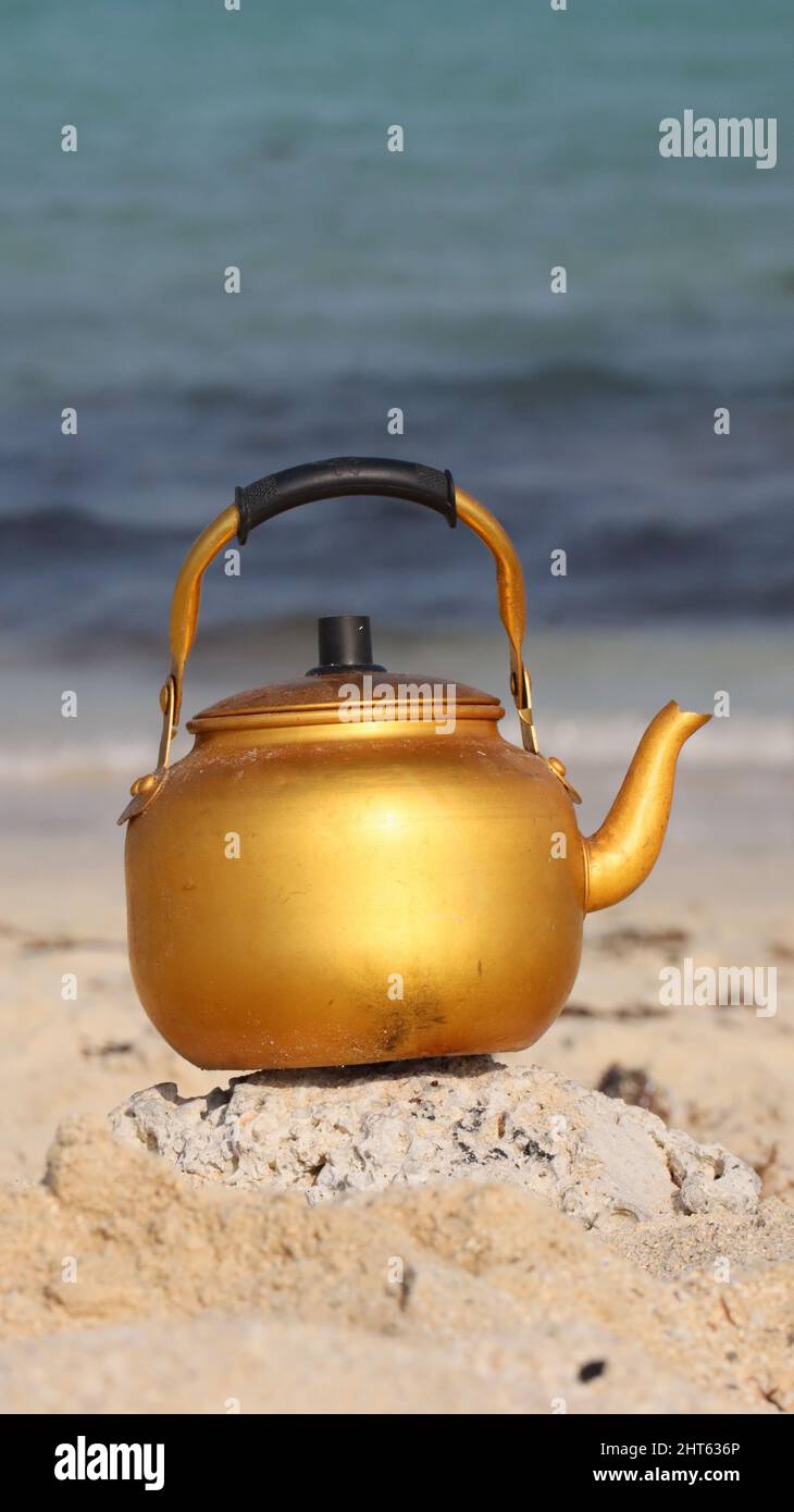 Golden Stailess Kettle at Qatar Beach Stock Photo - Alamy