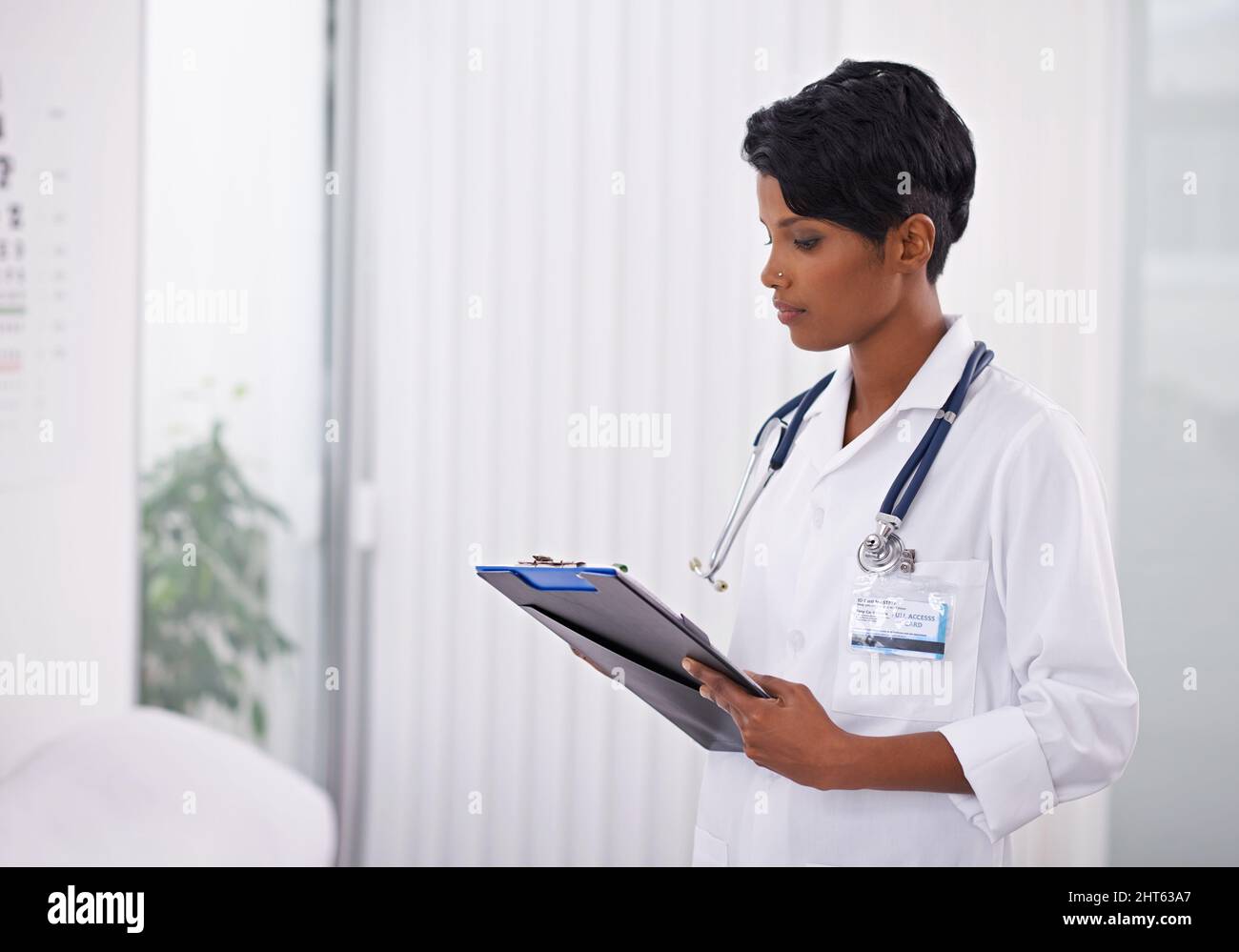 Giving you the best quality care. Cropped shot young doctor writing on ...