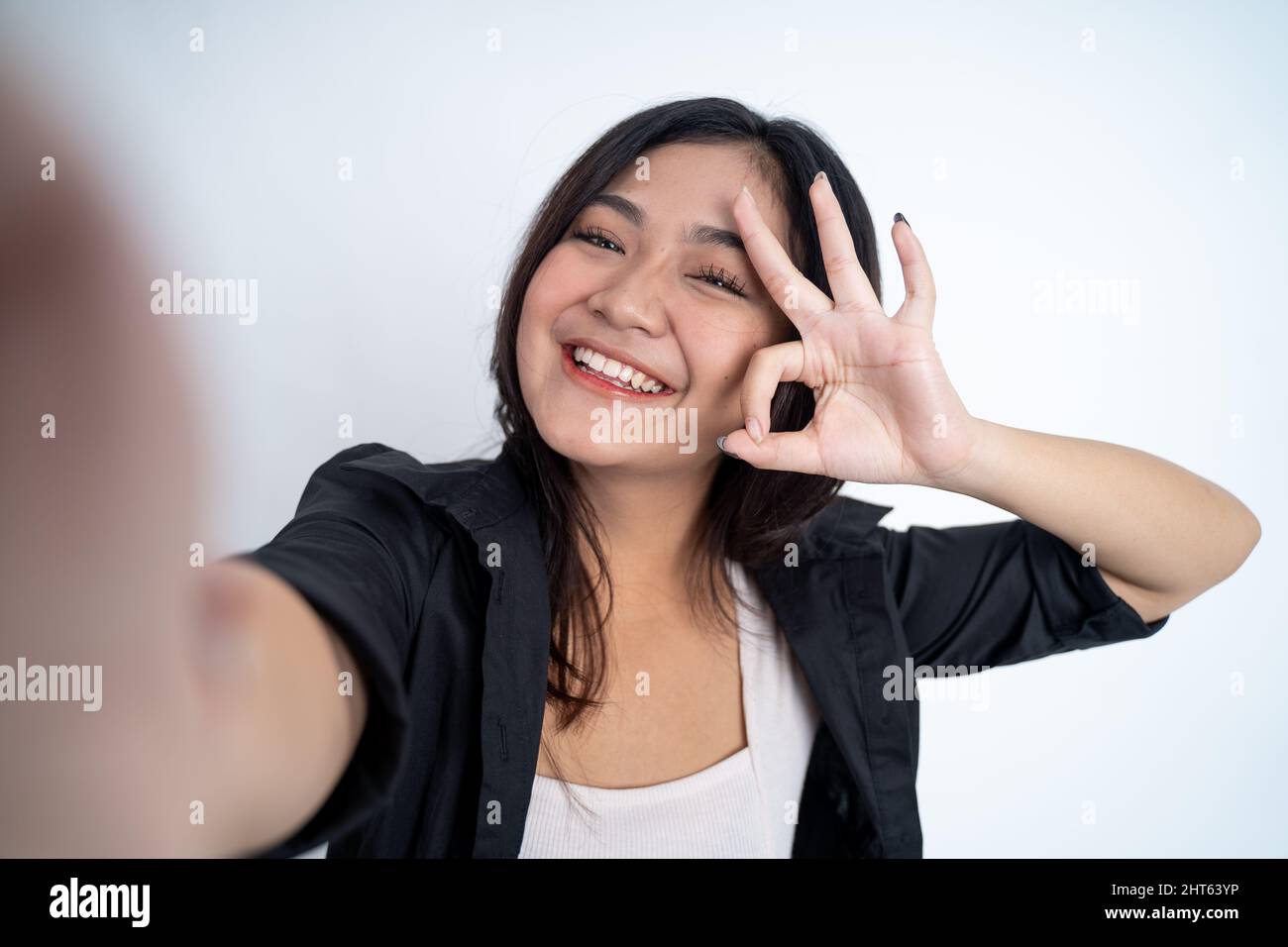 smiling asian woman take a selfie with ok hands gesture Stock Photo - Alamy