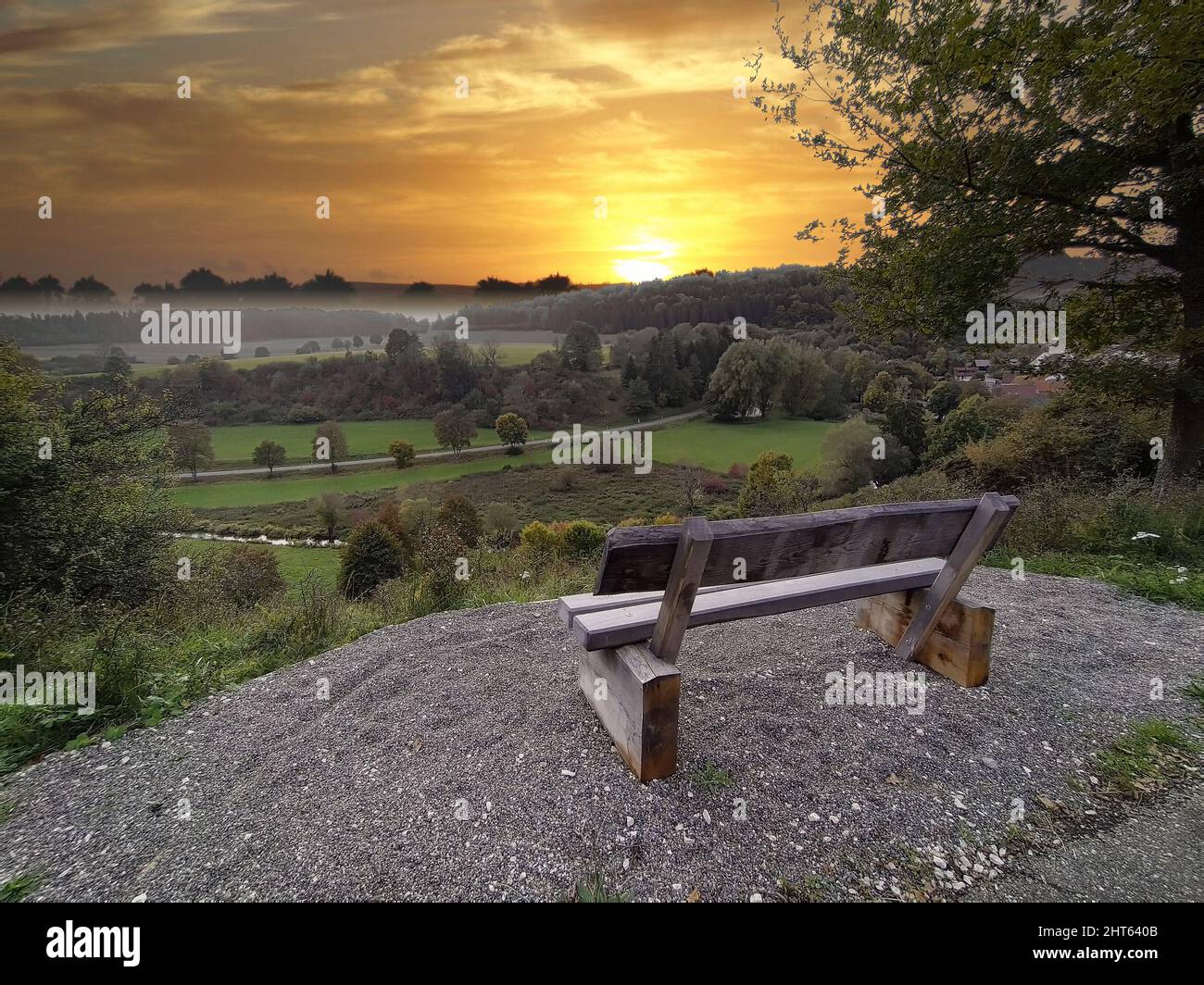 Bench on a hill in a rural park at sunset or sunrise Stock Photo - Alamy