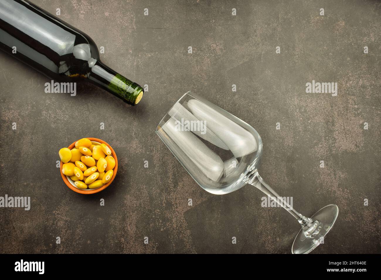Top view of a red wine glass and bottle on a stone background with ...