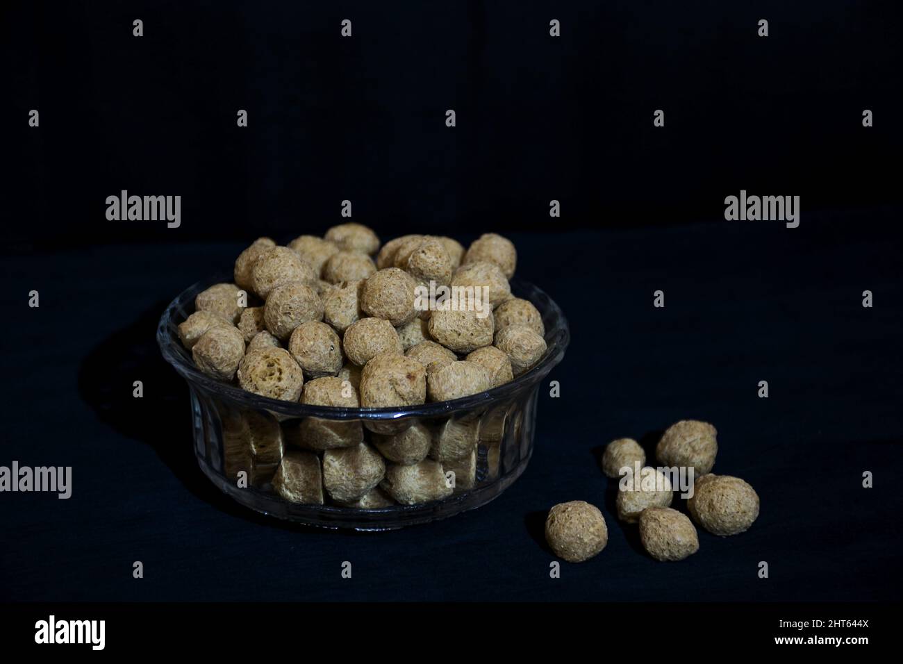 Glass bowl of mini soya chunks on a dark background Stock Photo - Alamy