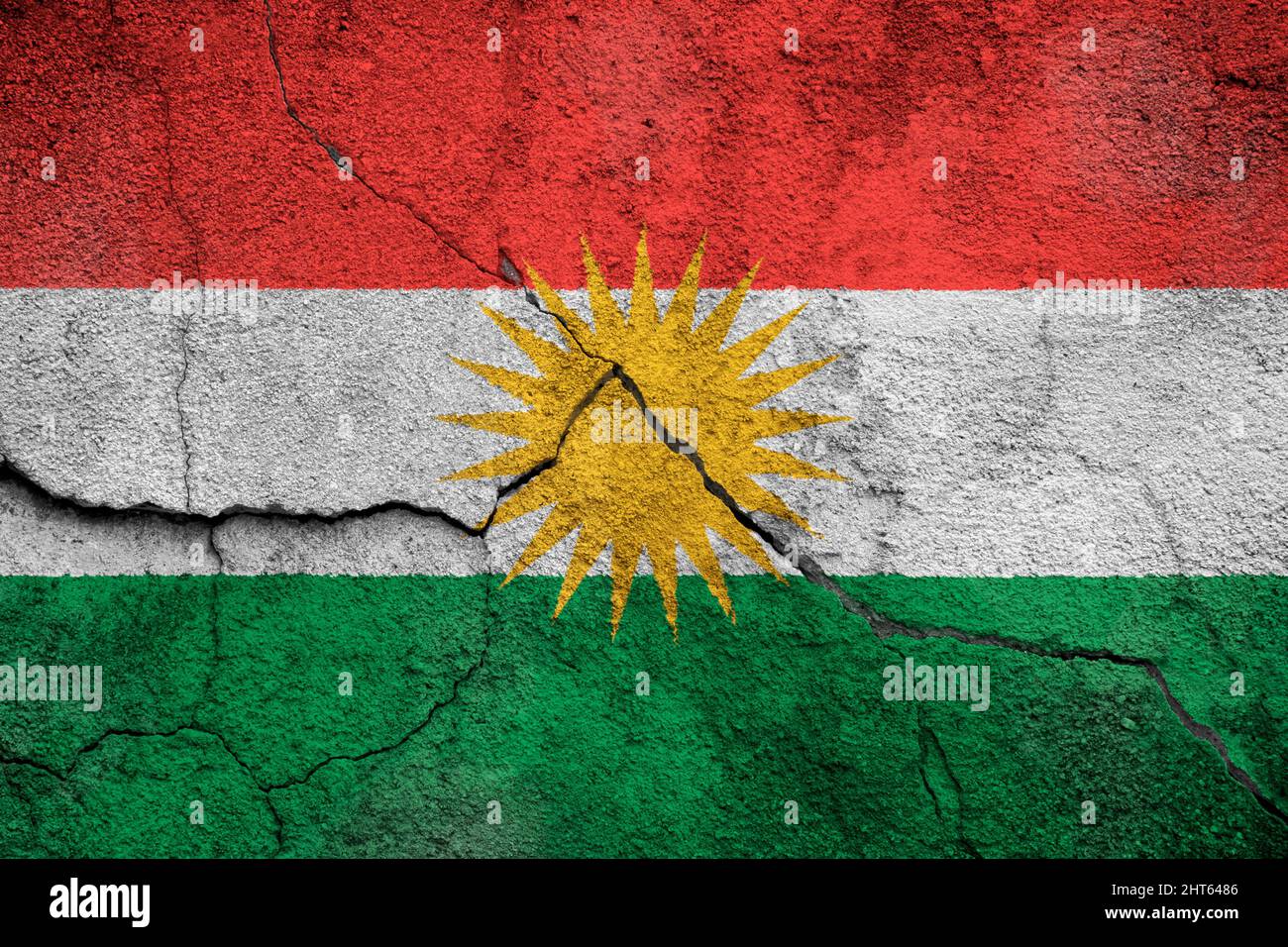 Full frame photo of a weathered flag of Kurdistan painted on a cracked ...