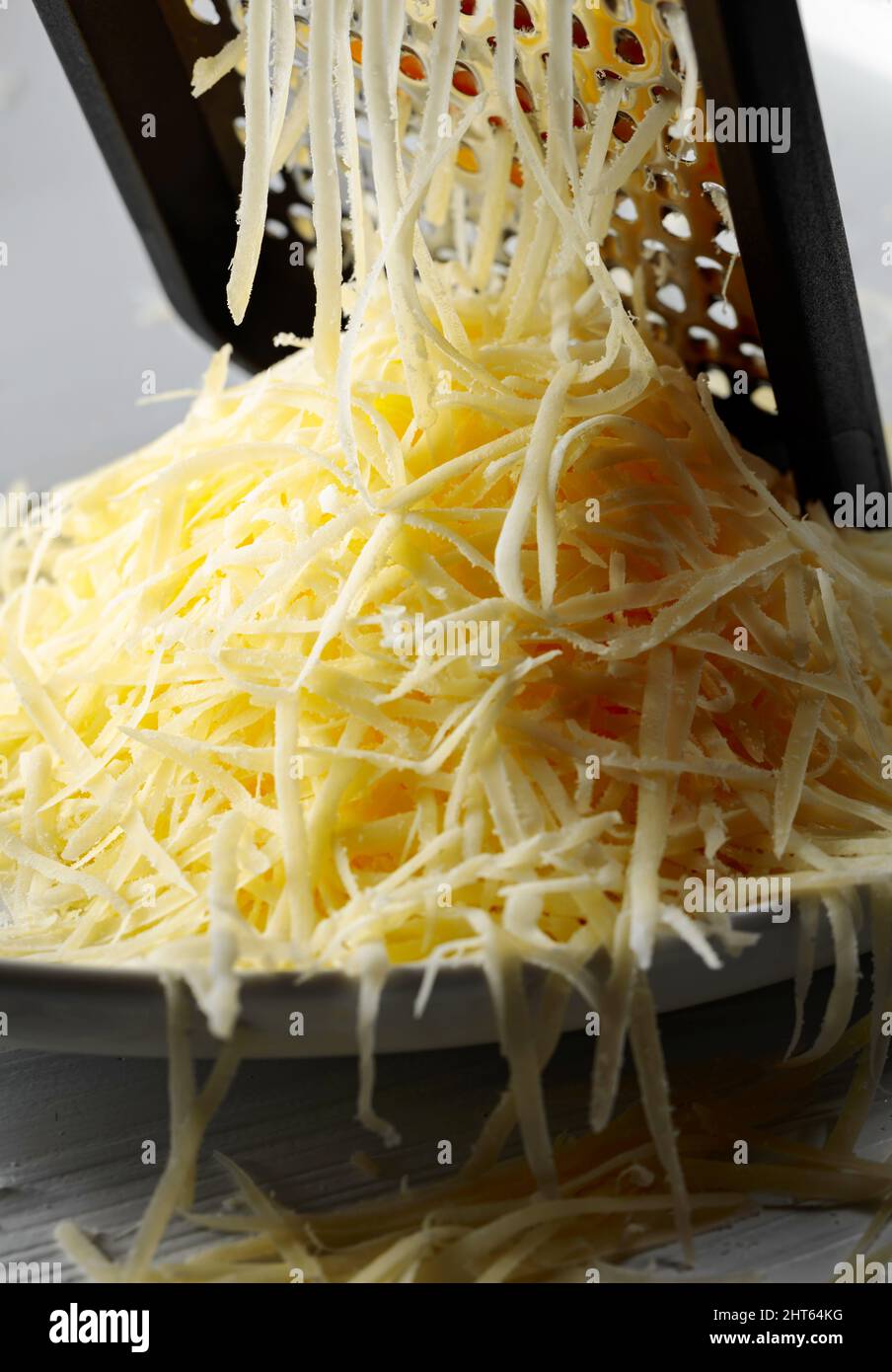 Grated cheese and grater. Concept: Italian cuisine, cheese, restaurant ...