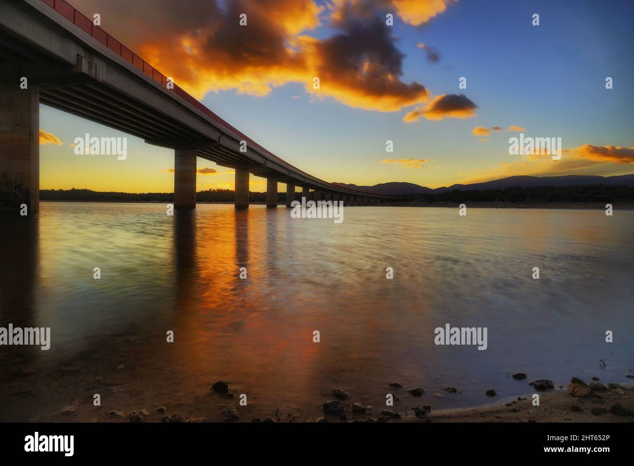 Beautiful bright sunset sky with clouds over a bridge Stock Photo - Alamy