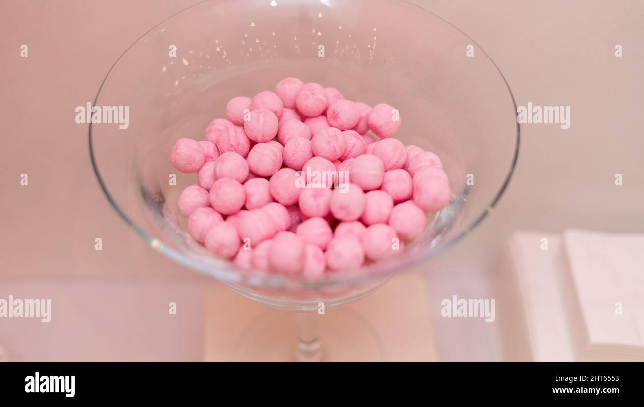 Selective closeup of pink round candies in a jar Stock Photo - Alamy