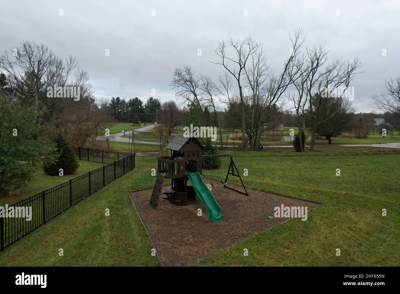 Aerial view of a playhouse with a slide in an empty playground of a ...