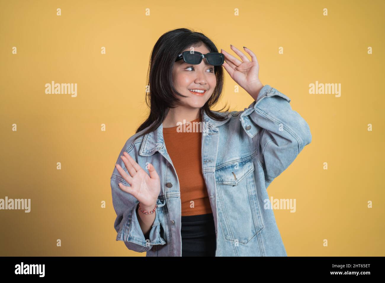 excited woman smiling while taking off sunglasses while waving Stock ...
